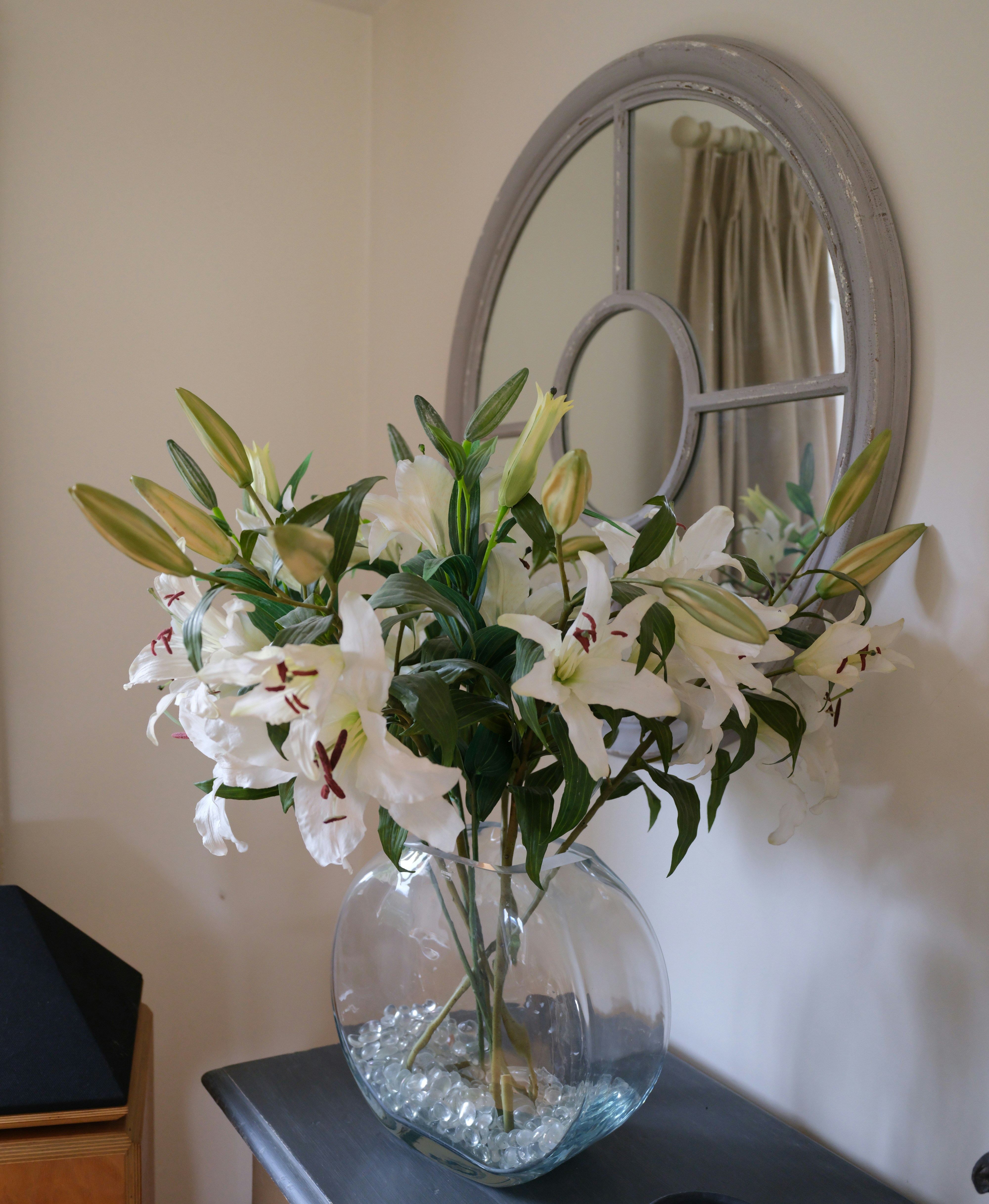 Lily Bouquet in Glass Vase Against Soft Mirror Backdrop