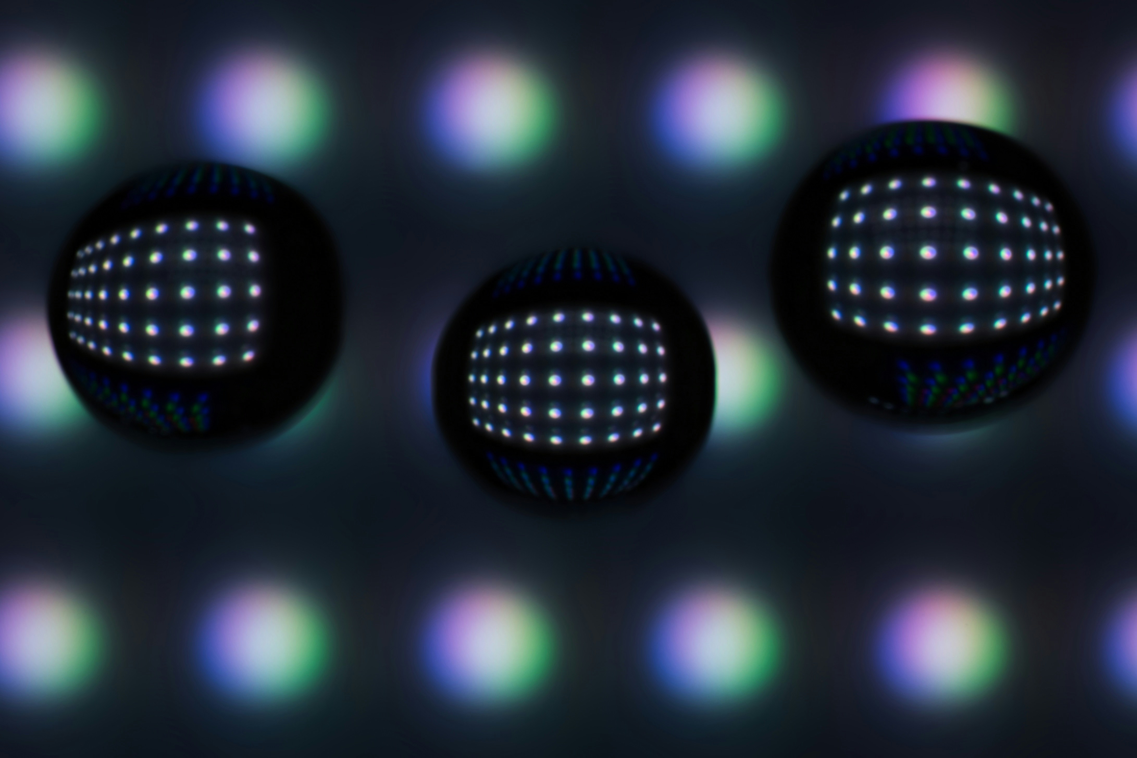 Orbital Dots: A Trio of Backlit Orbs in Neon Blur