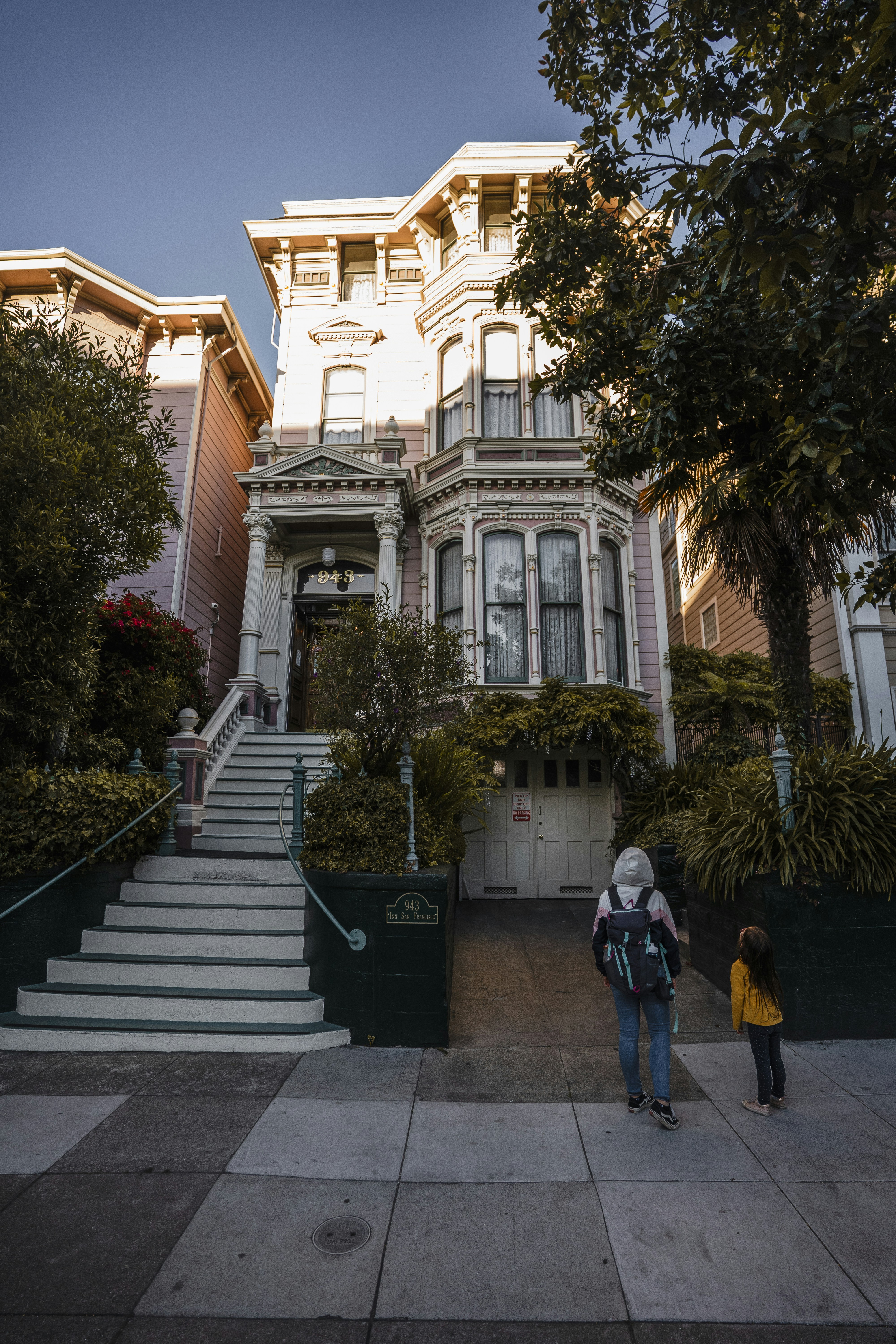 Staircase Ascent: A Victorian Facade Framed by Garden Foliage
