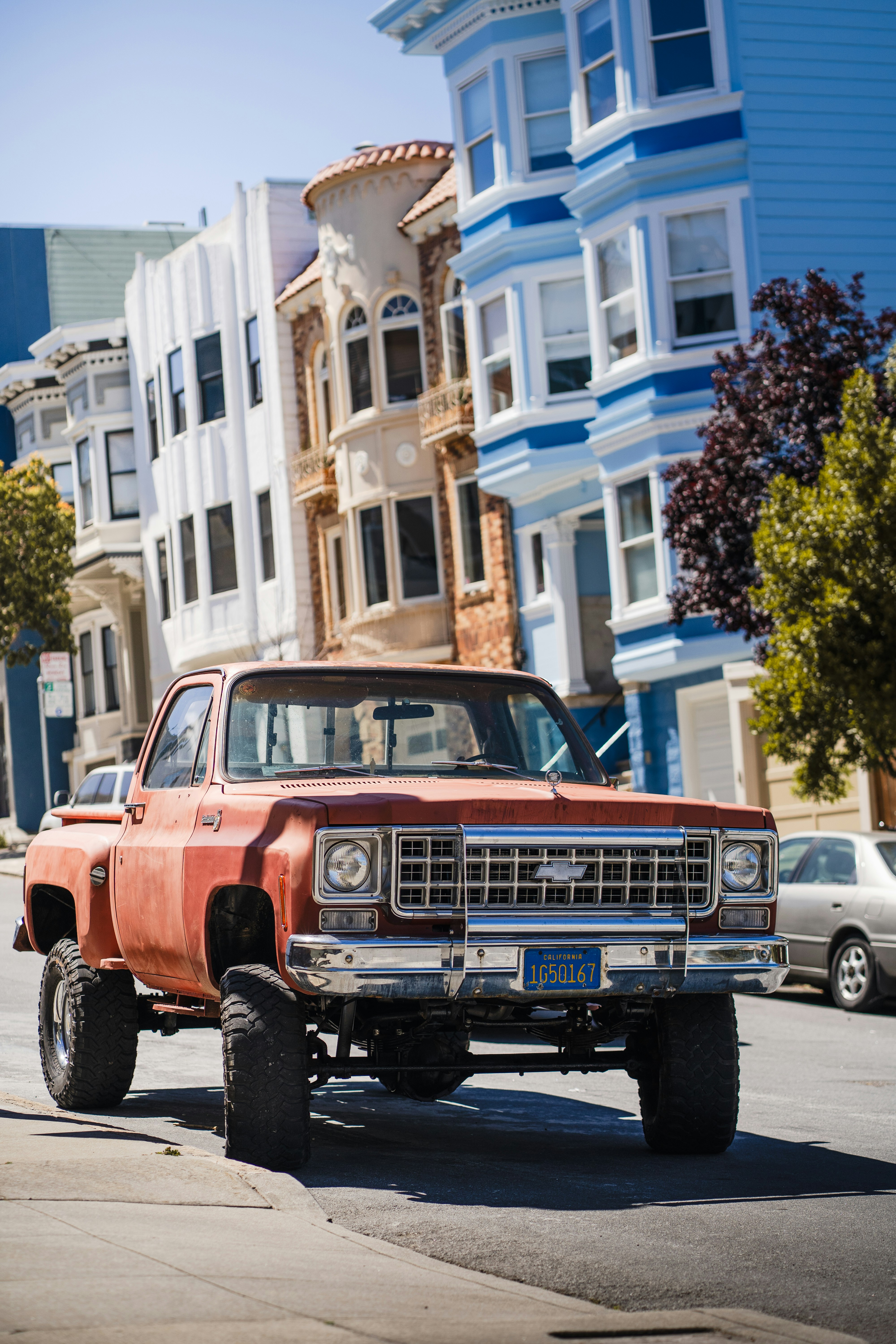 Raised in the City: A Weathered Pickup Amid Colorful Victorian Facades