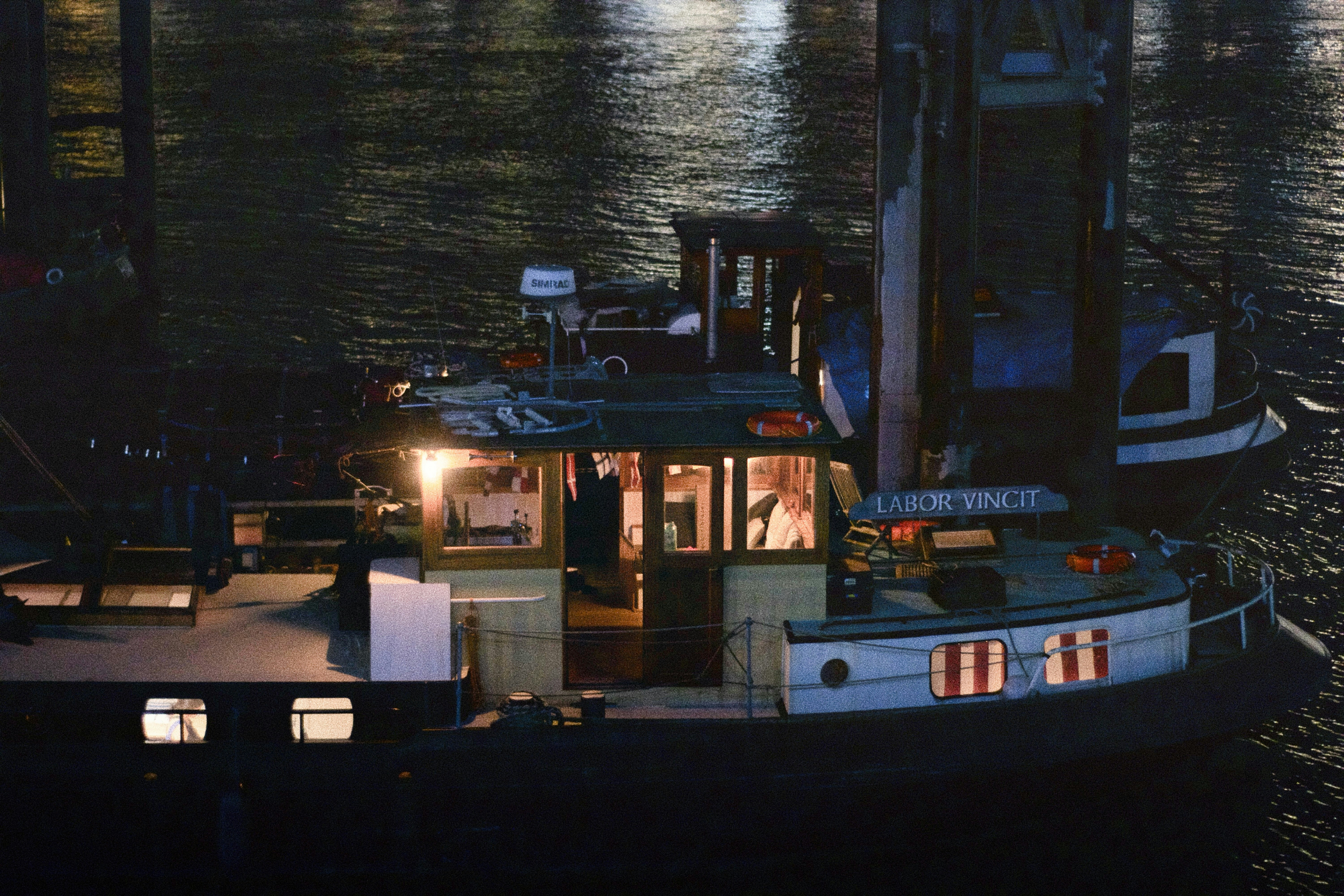Night Channel: Warm Cabin Glow on a Waterfront Vessel