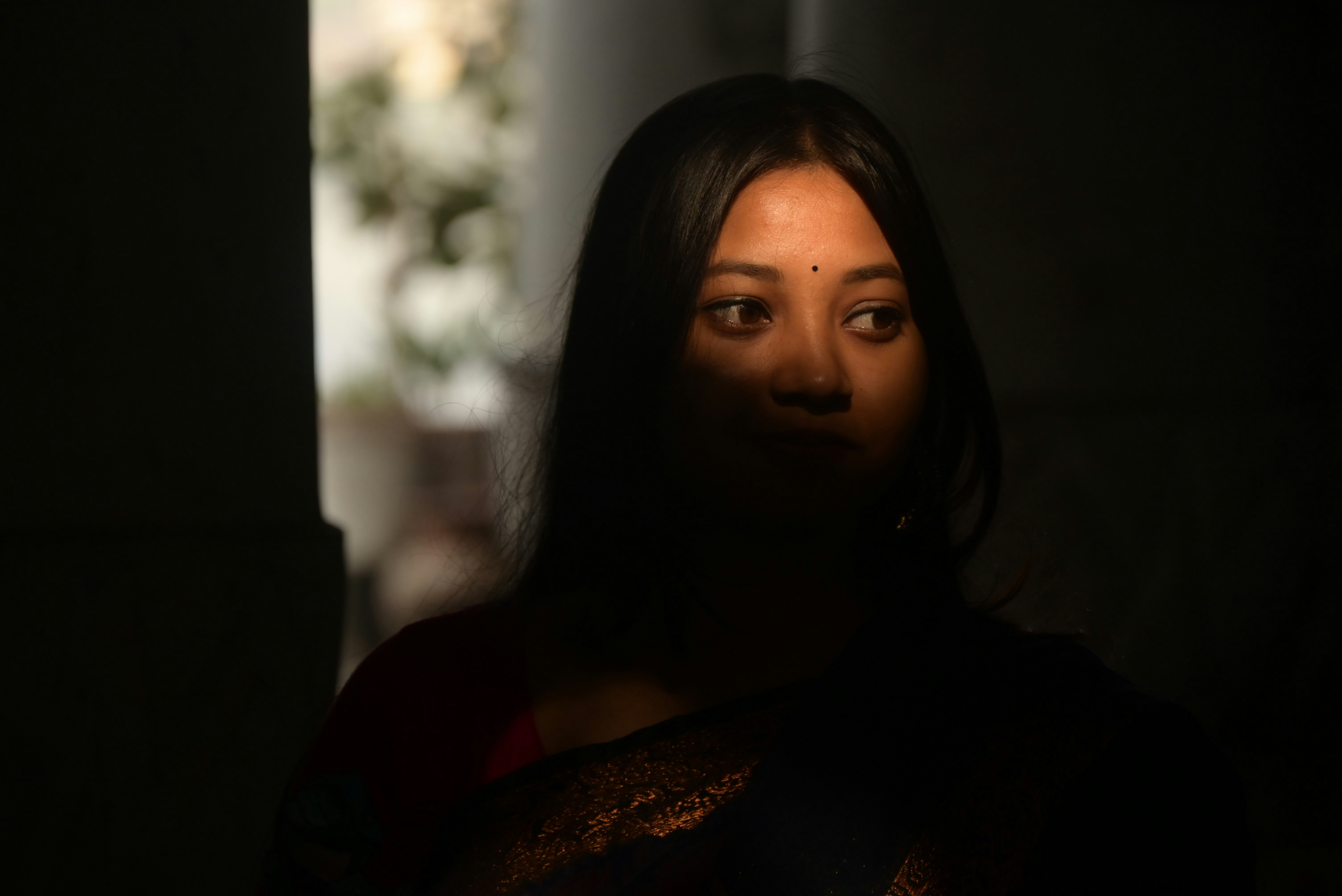 Shadowed Portrait: A Quiet Glance in a Dim Corridor