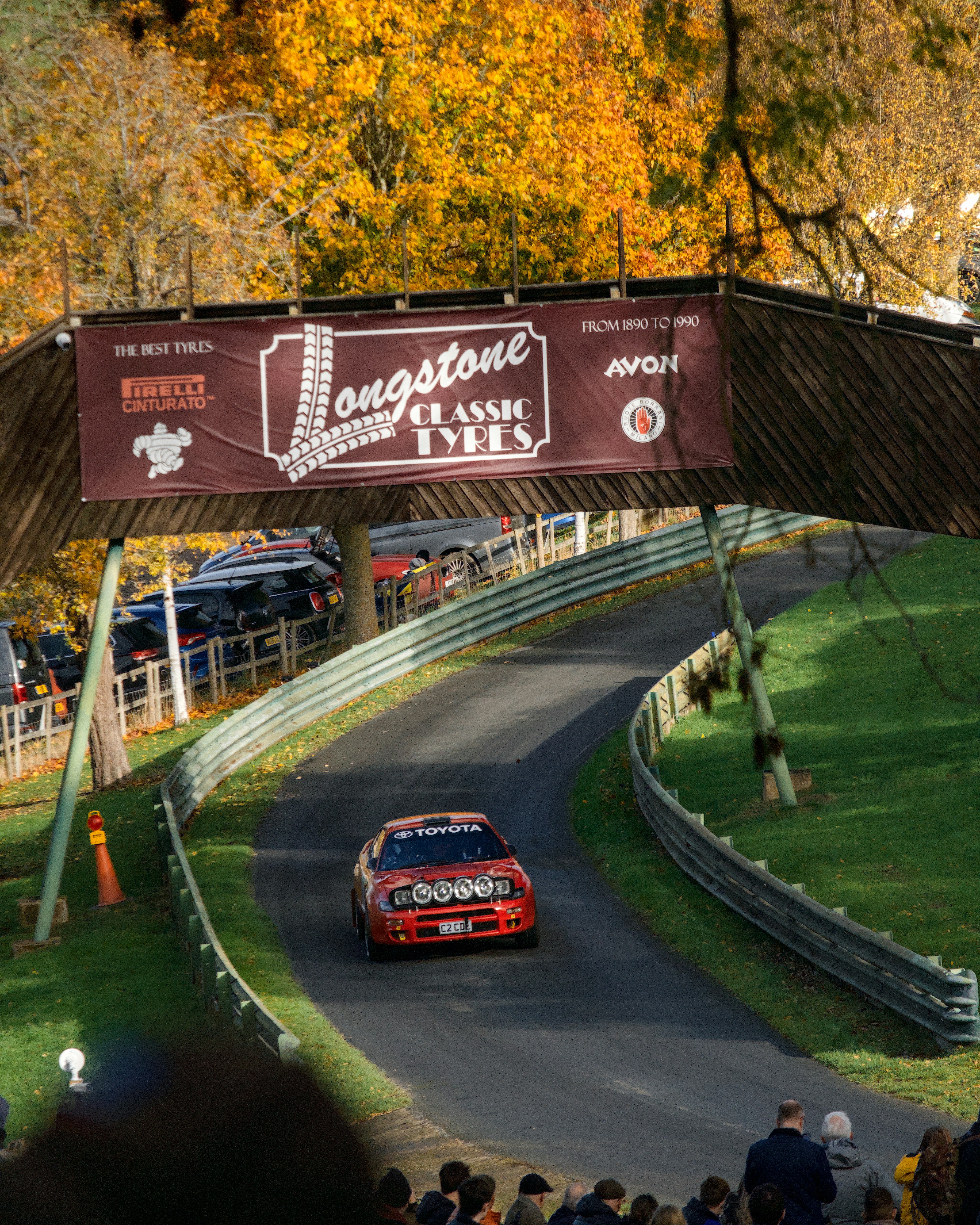 Sprint Through Autumn: A Red Rally Car Carves the Hill