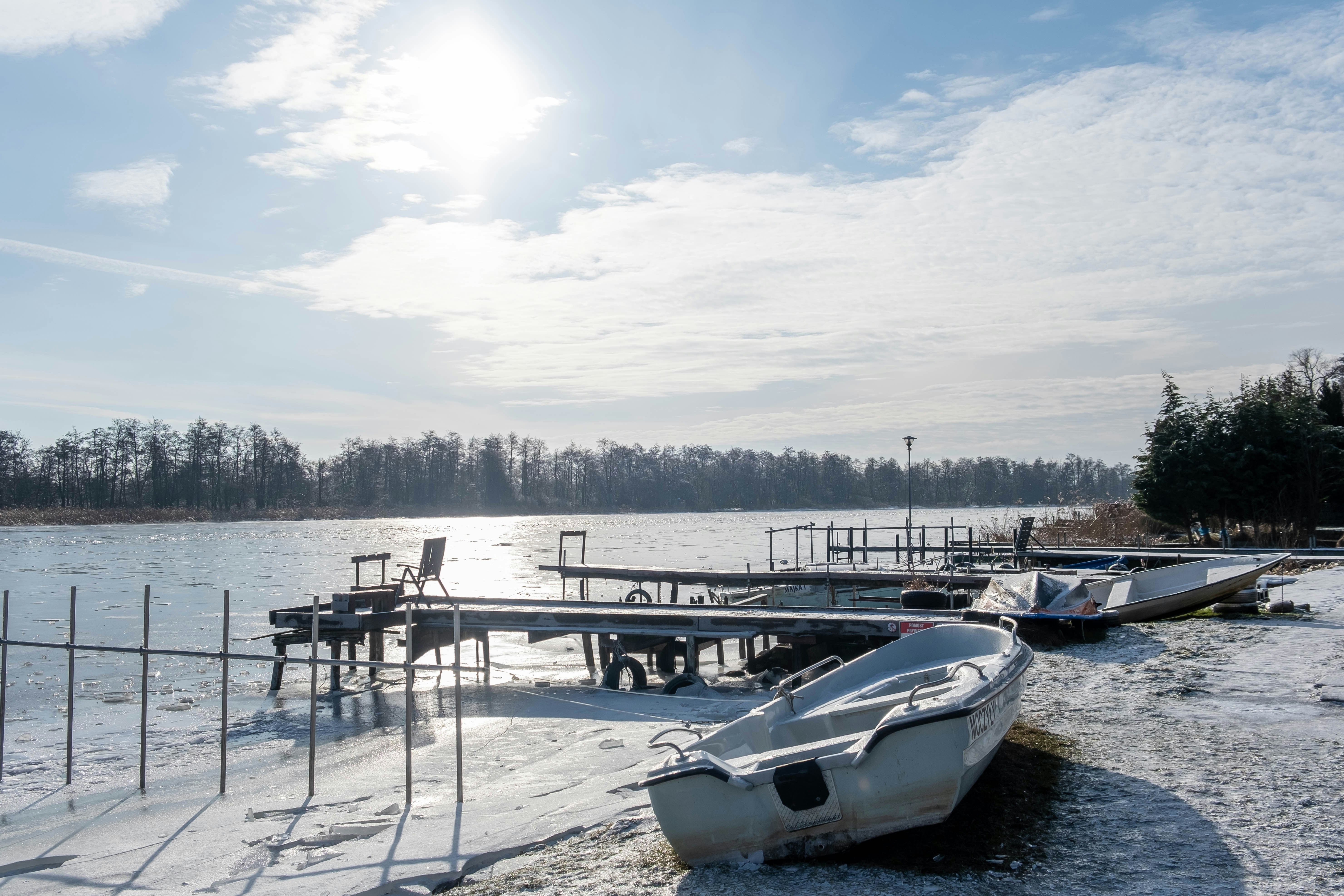 Sunlit Boats at a Quiet Winter Lake Dock