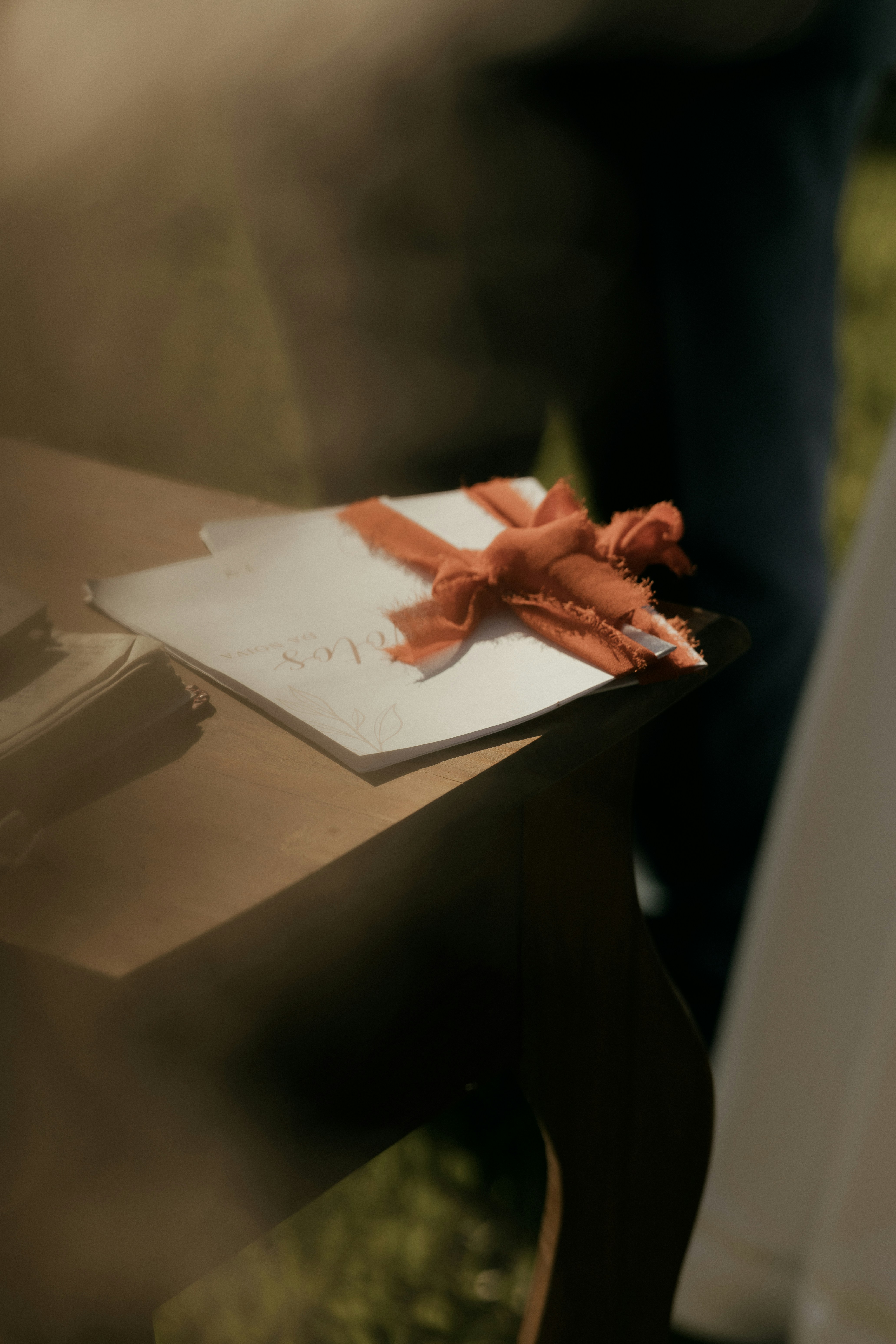 A Frayed Ribbon Resting on a Letter