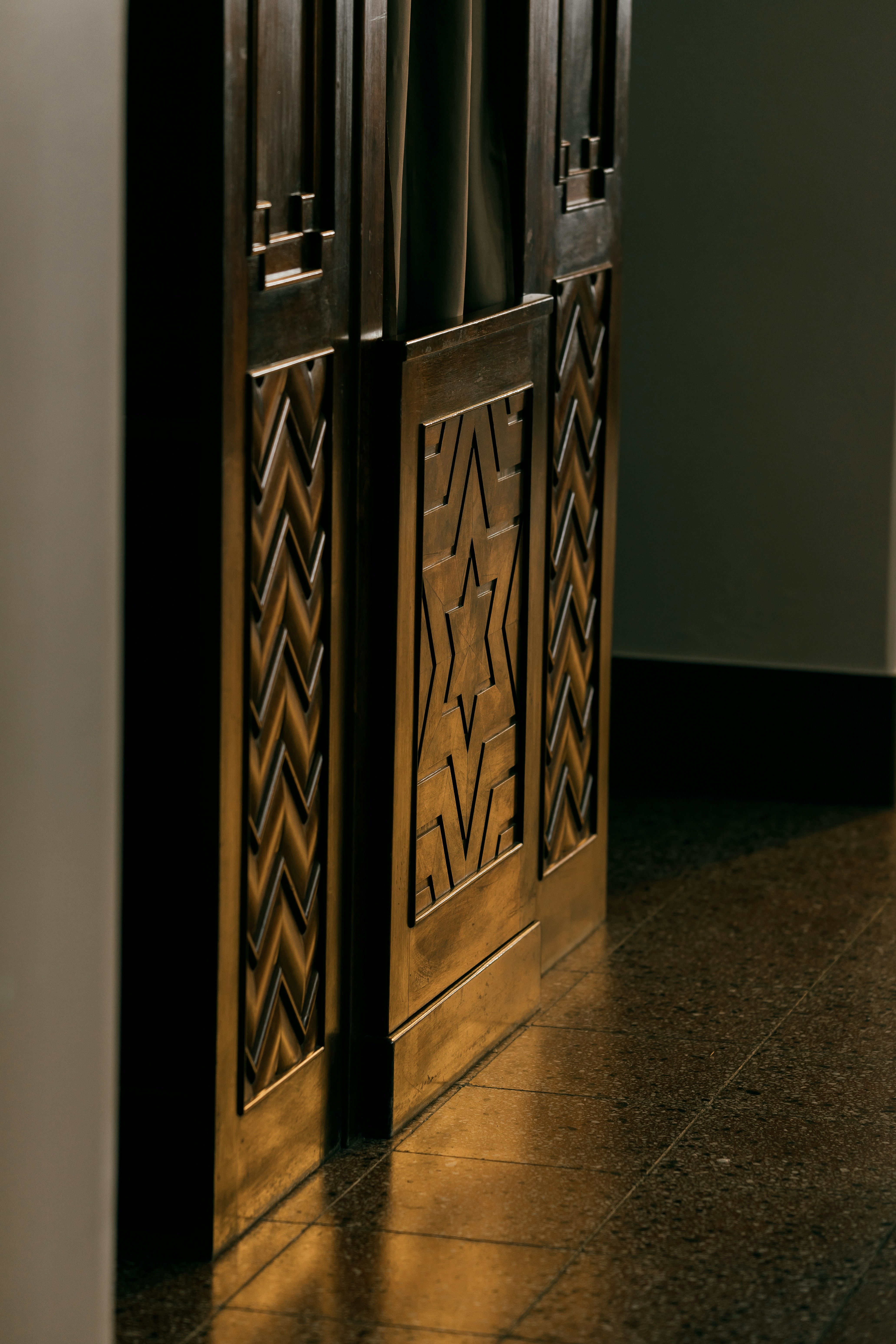 Ornate Elevator Doors in Dim Corridor