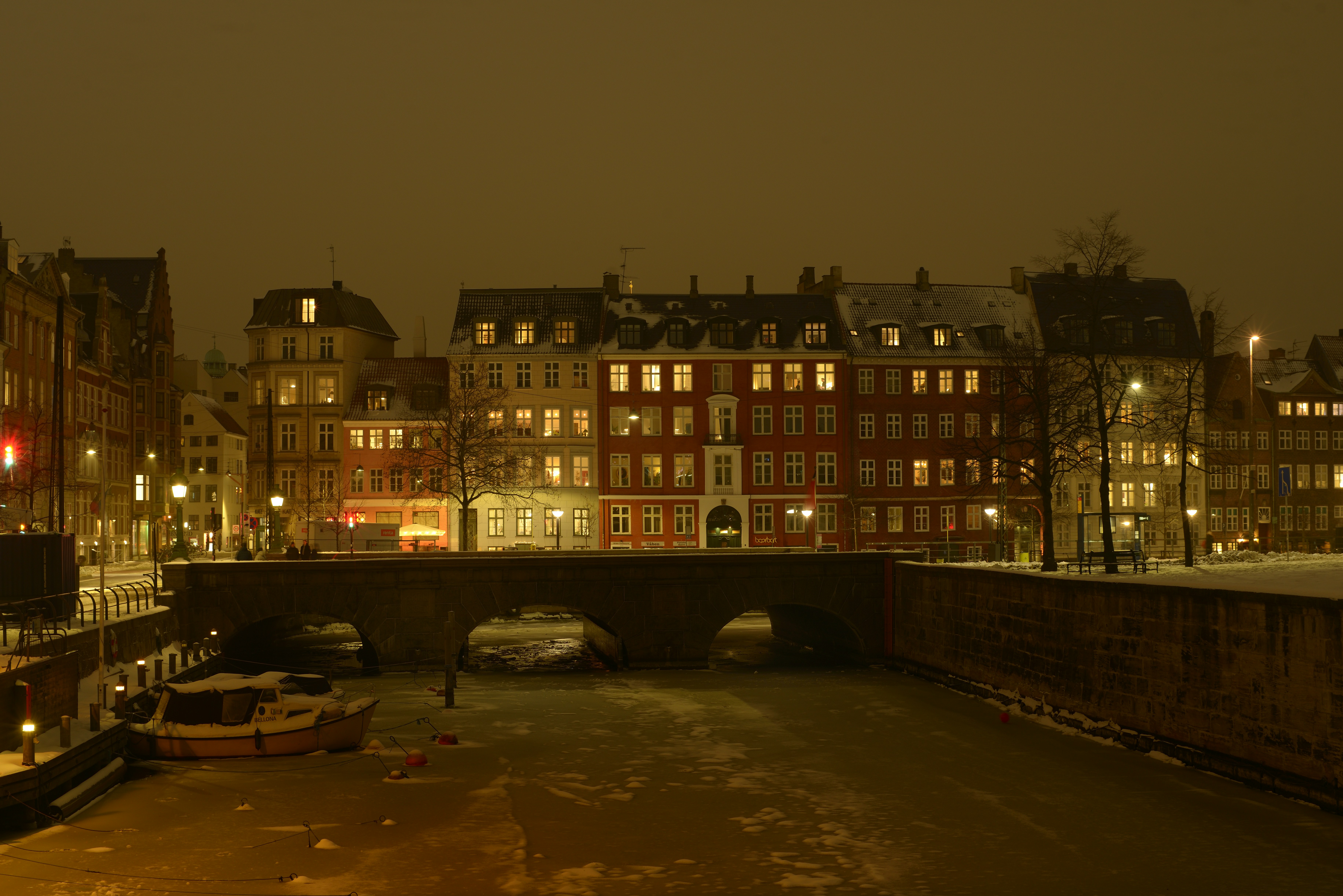Warm Canal Night: Arcaded Bridge and Snowy Riverside
