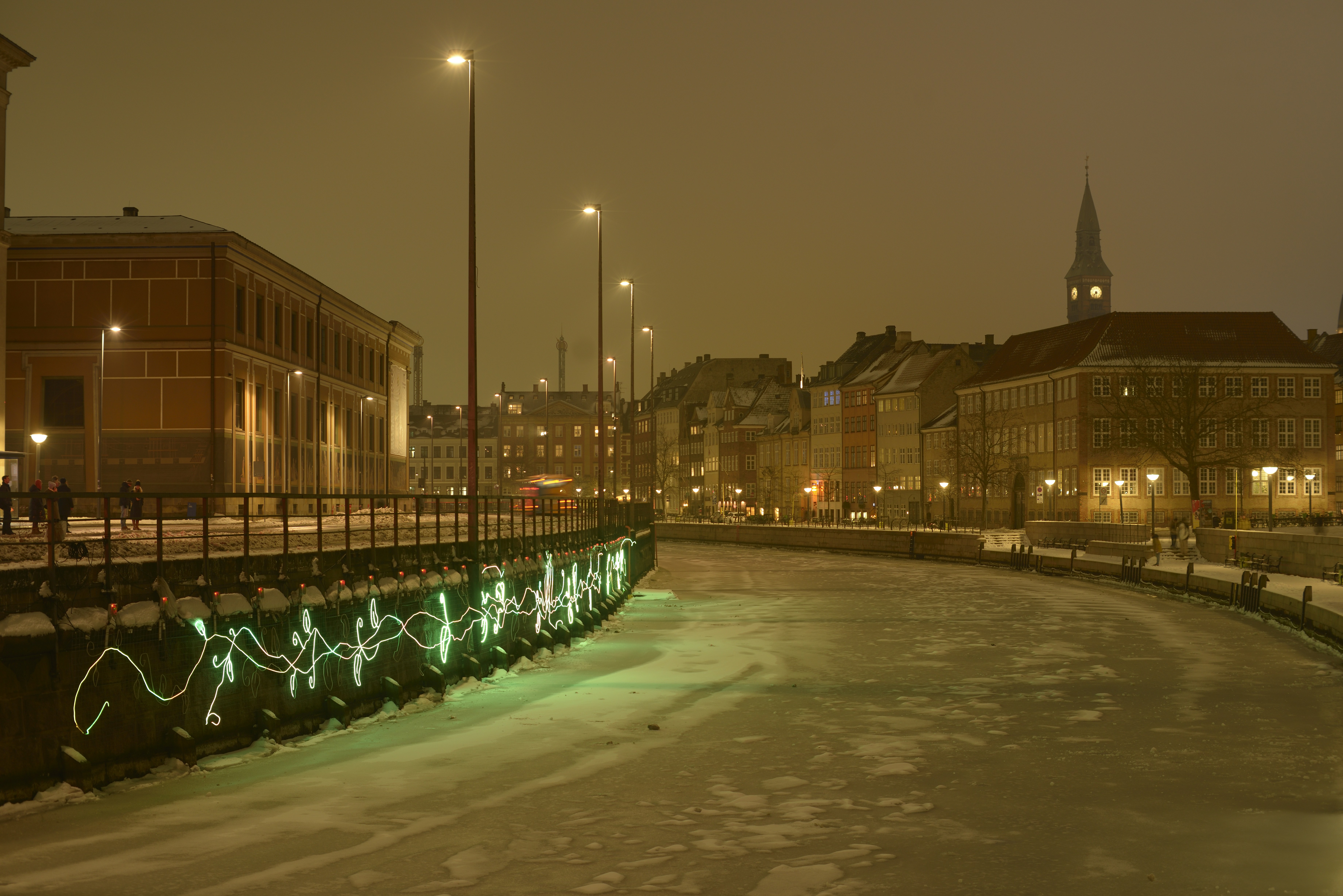 Glowing Canal Promenade Under Evening Lamps