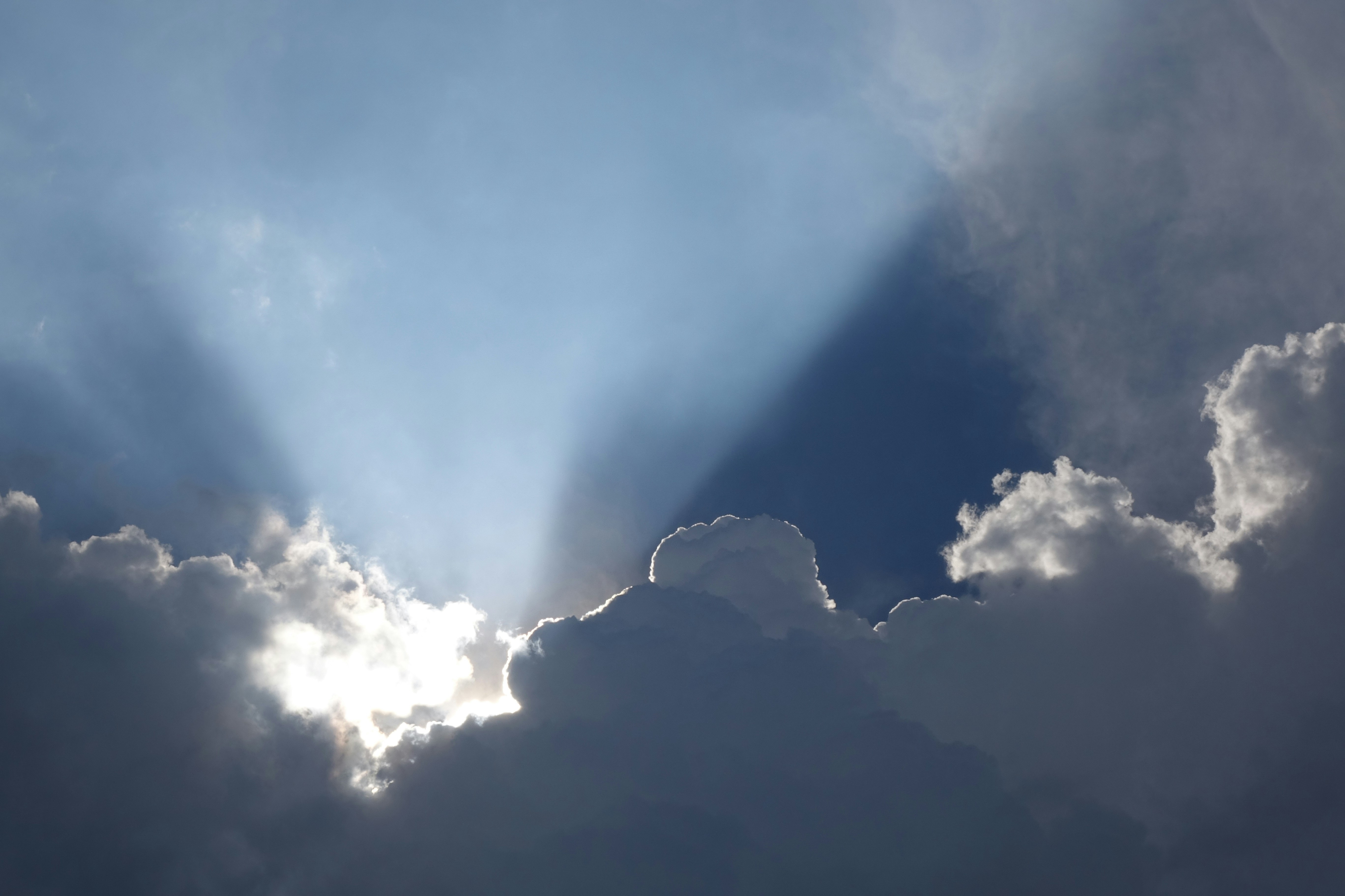 Sunbeams breaking through dark storm clouds