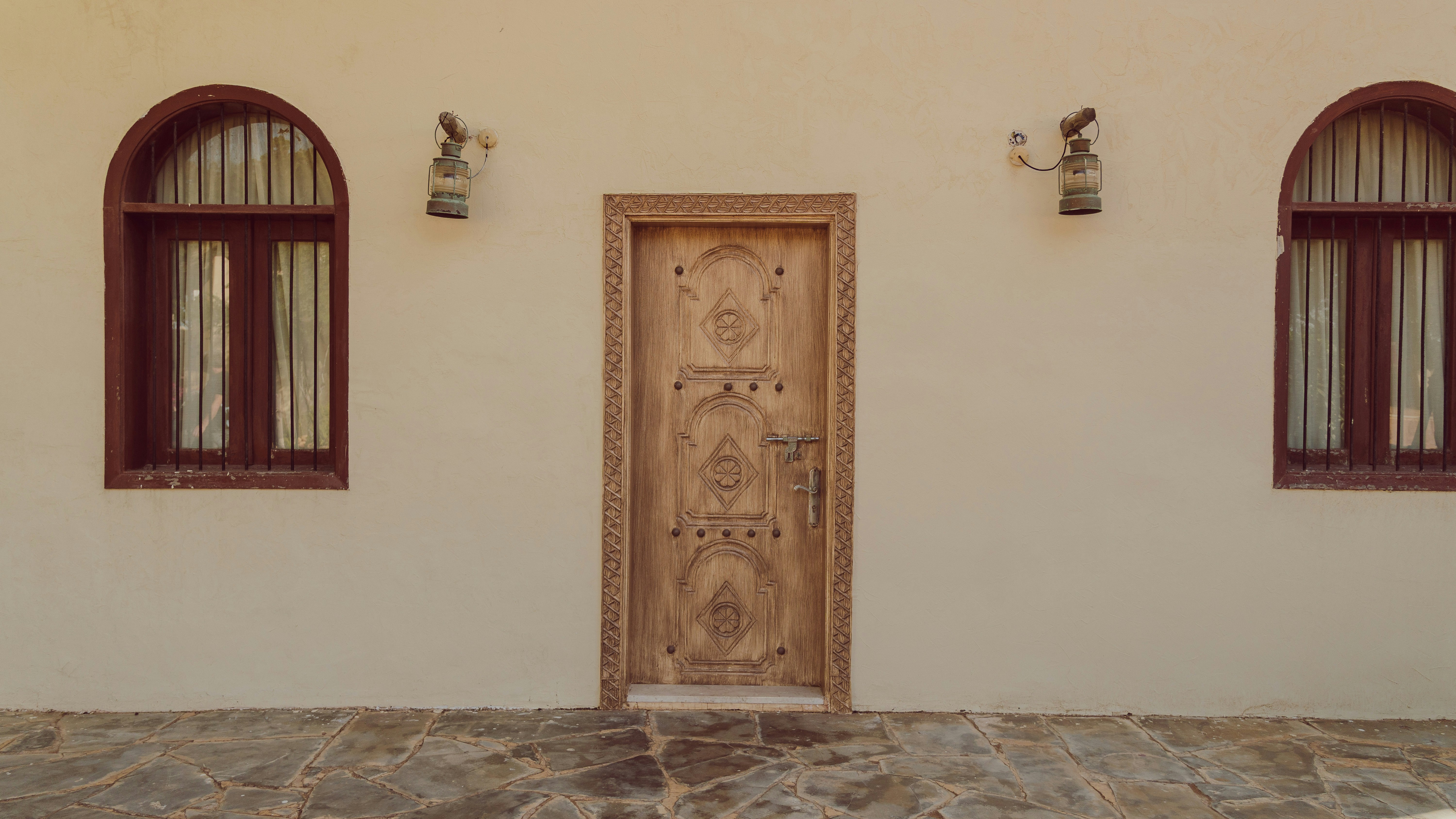 Symmetrical doorway on sunlit adobe wall
