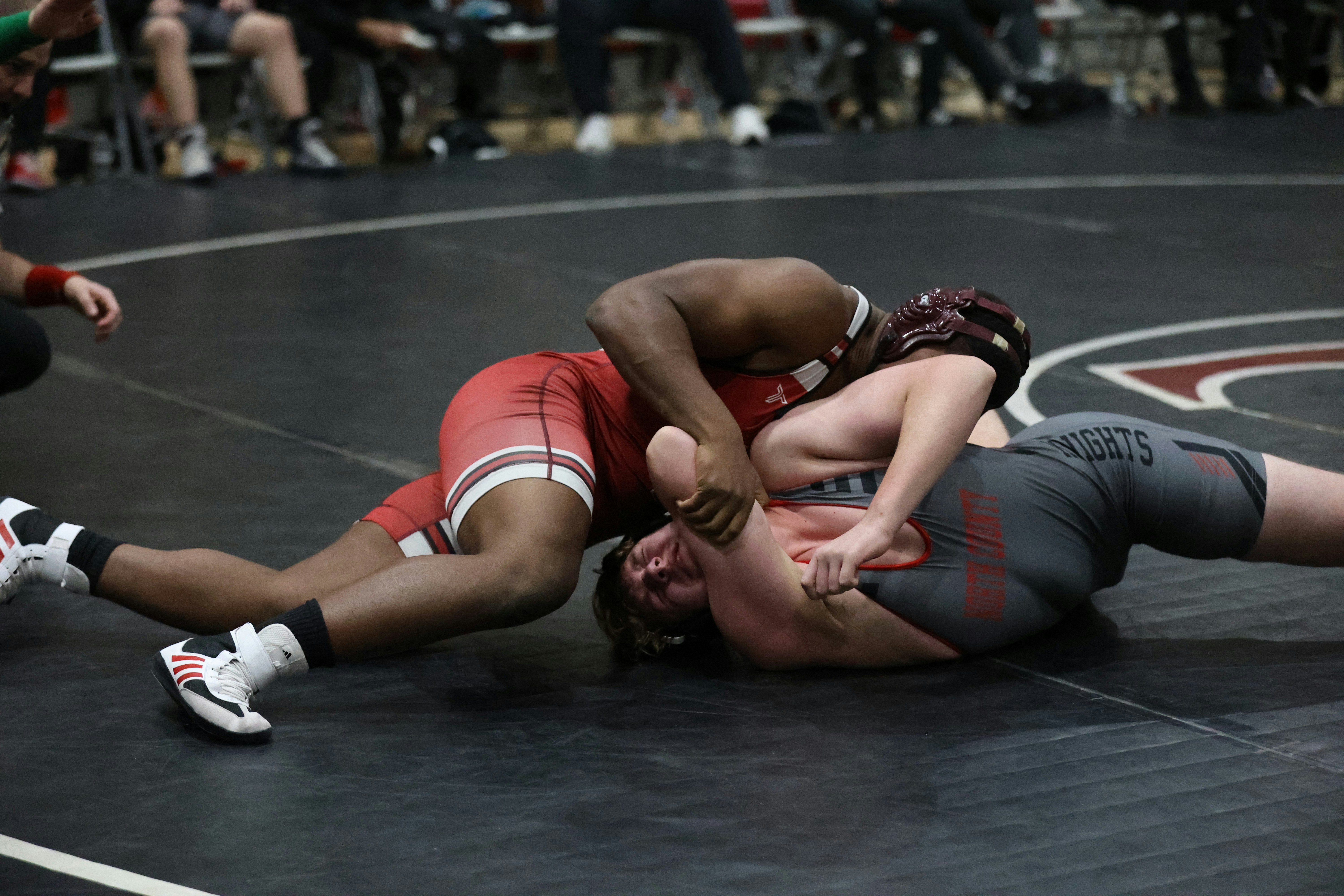 Pinned in Red: A Wrestler's Grasp in the Circle