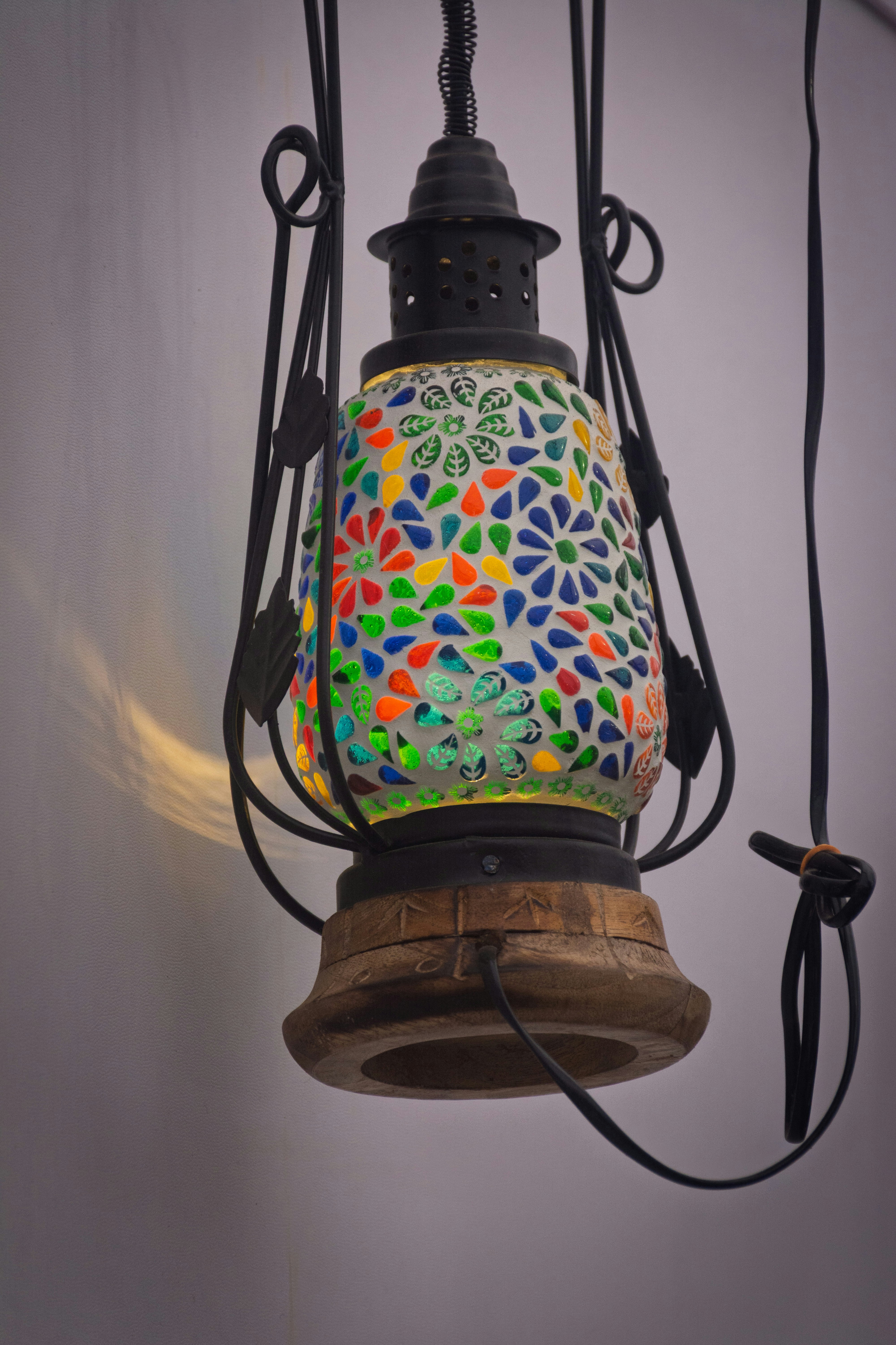 Glass Mosaic Lantern: Colorful Glow Amid Hanging Cables