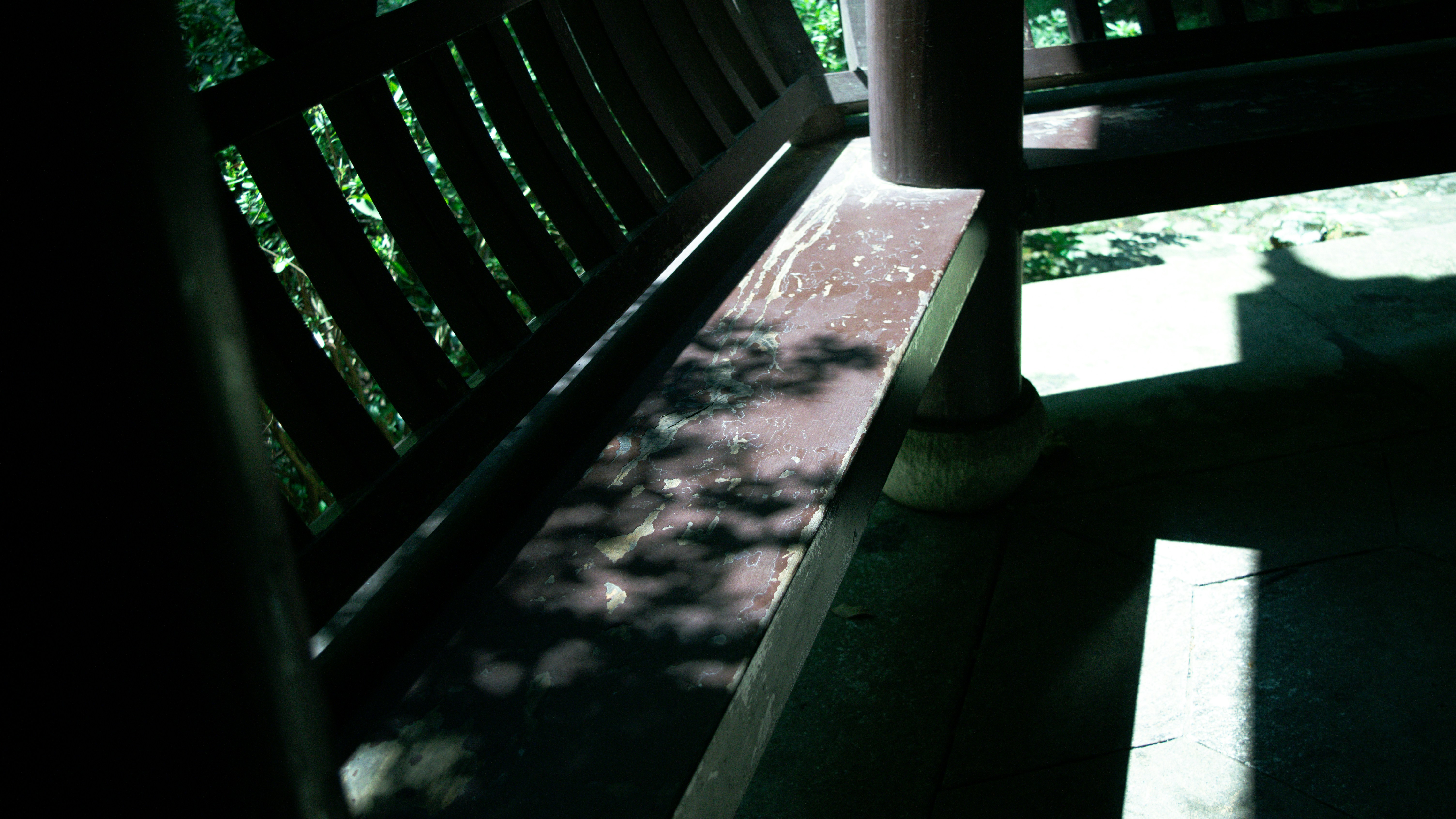 Shadowed Balcony Walkway Under Dappled Sunlight