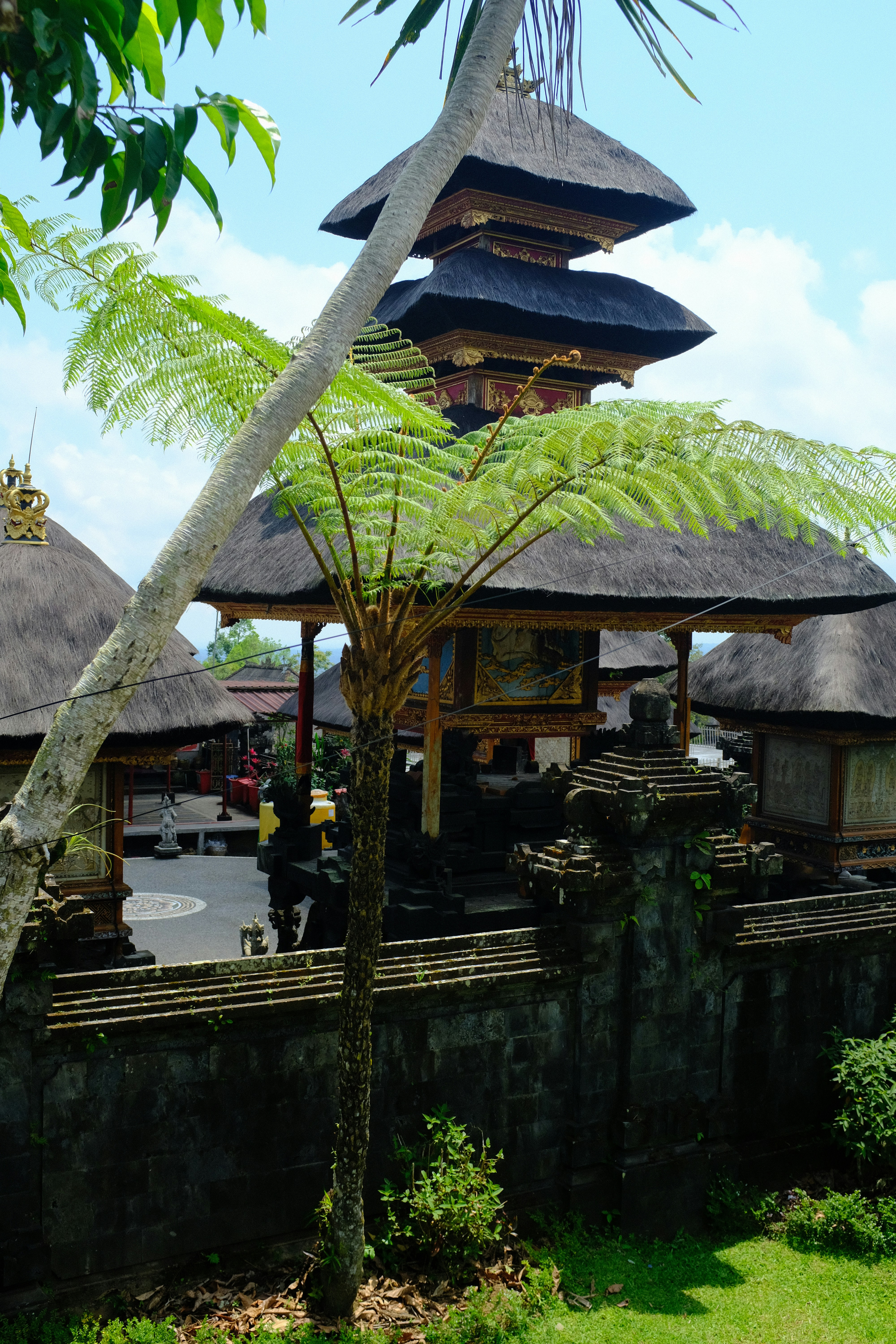 Thatched Temple Tiers Amid Fronds: A Balinese Courtyard Vista