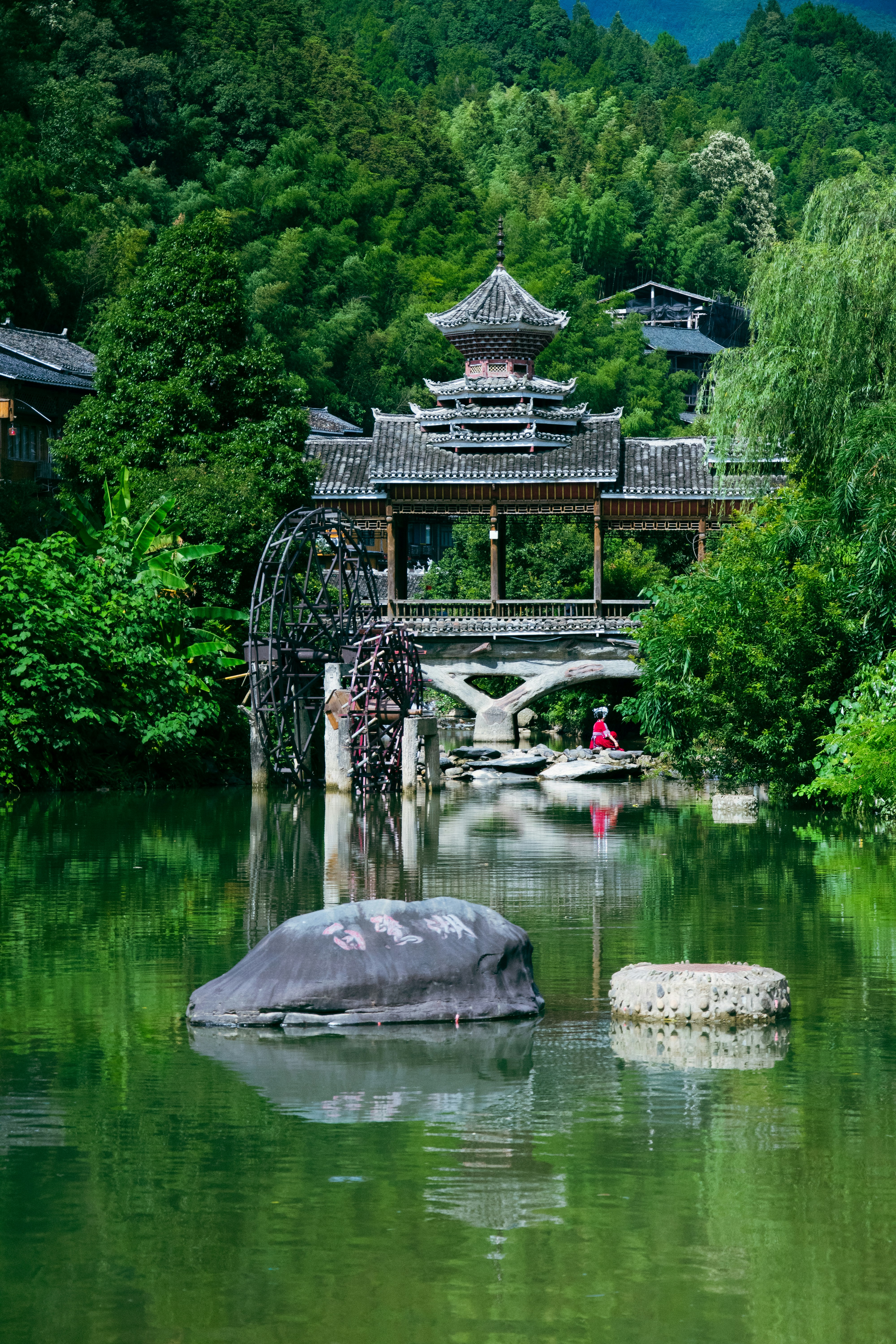 Sunlit Pond and Temple Bridge: Tranquil Green Reflections