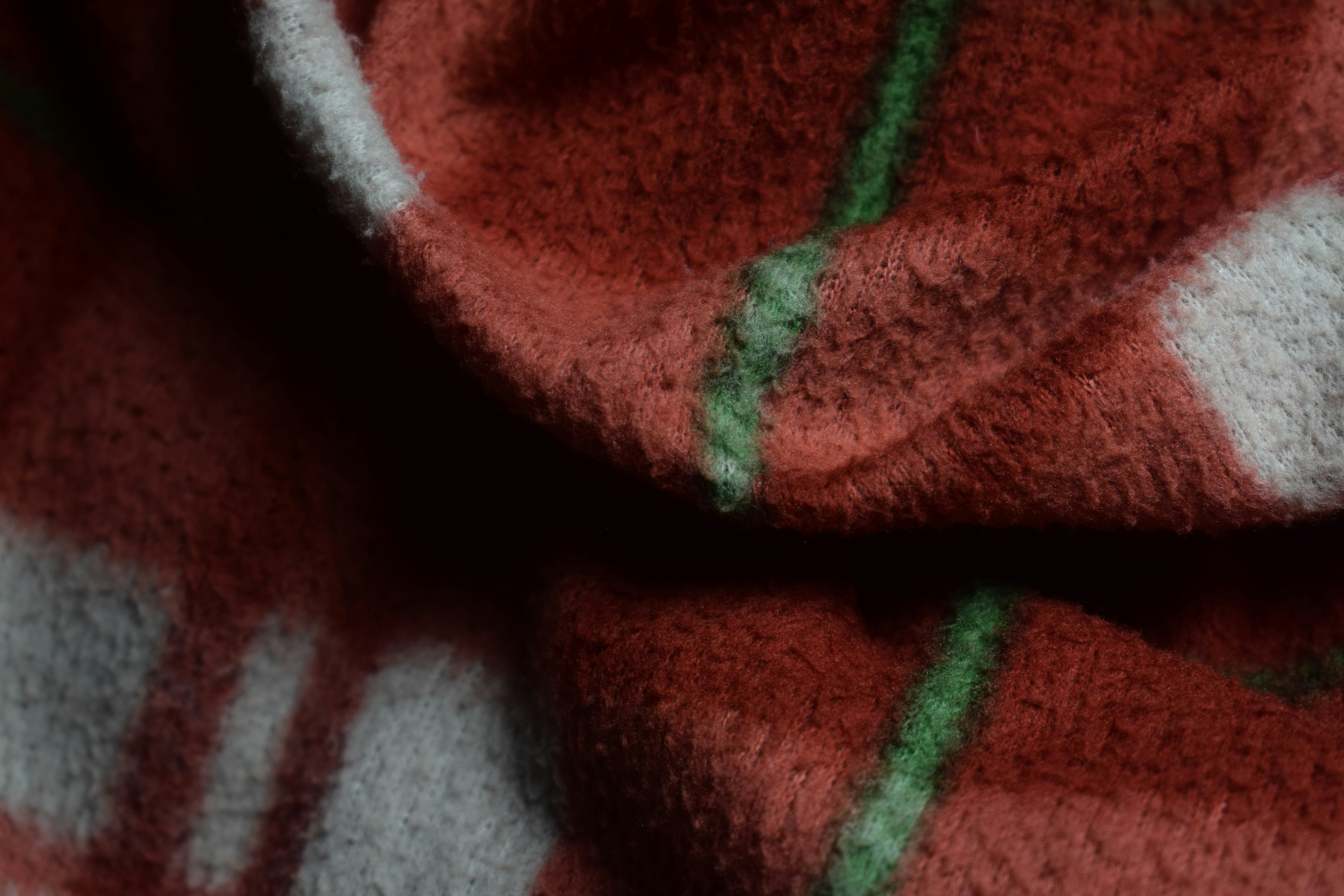 Red Wool Echo: A Close-Up of Textured Plaid Fabric Fold
