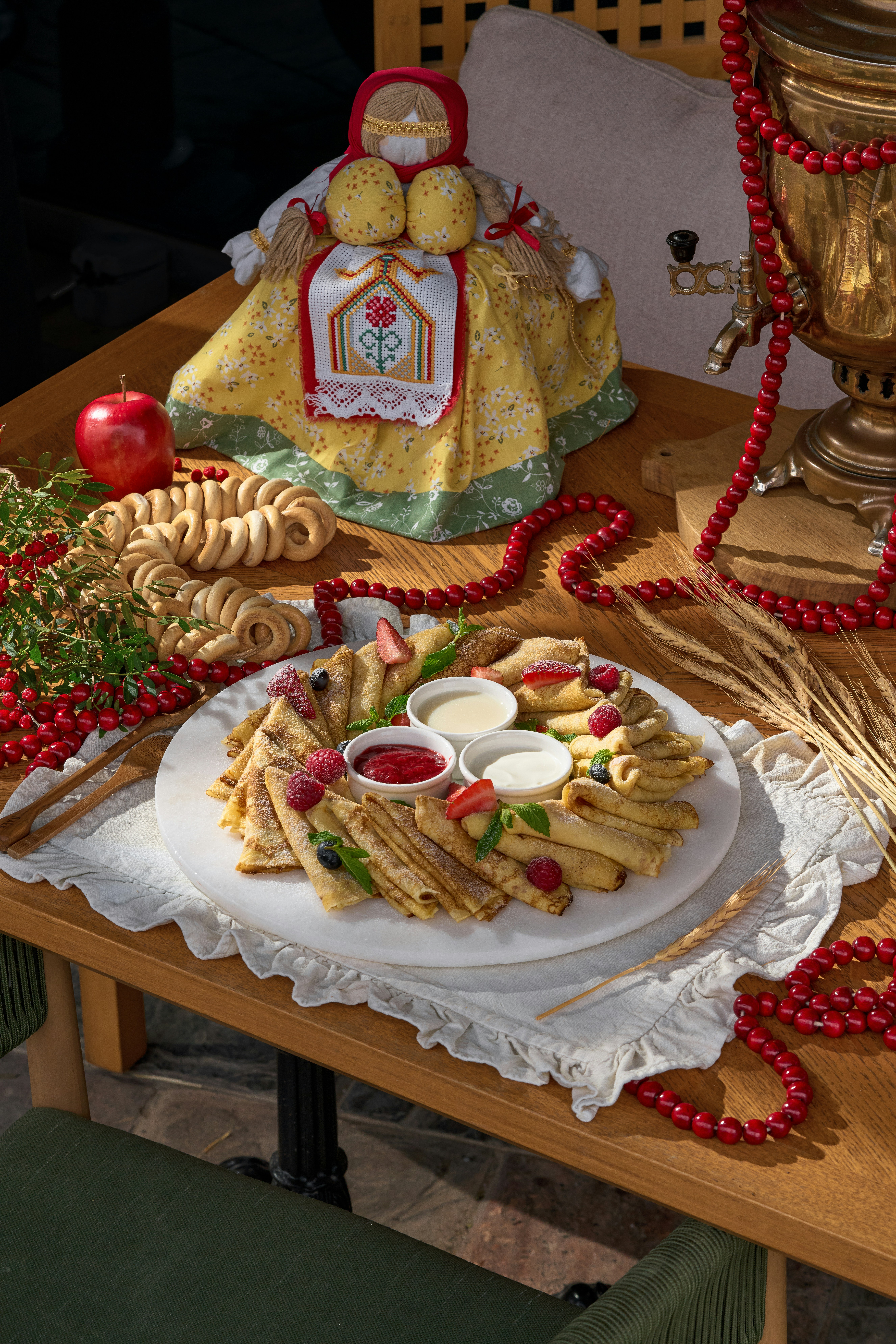 Heritage Table: Savory Pastry Arrangement with Red Beads and Folk Stitchwork