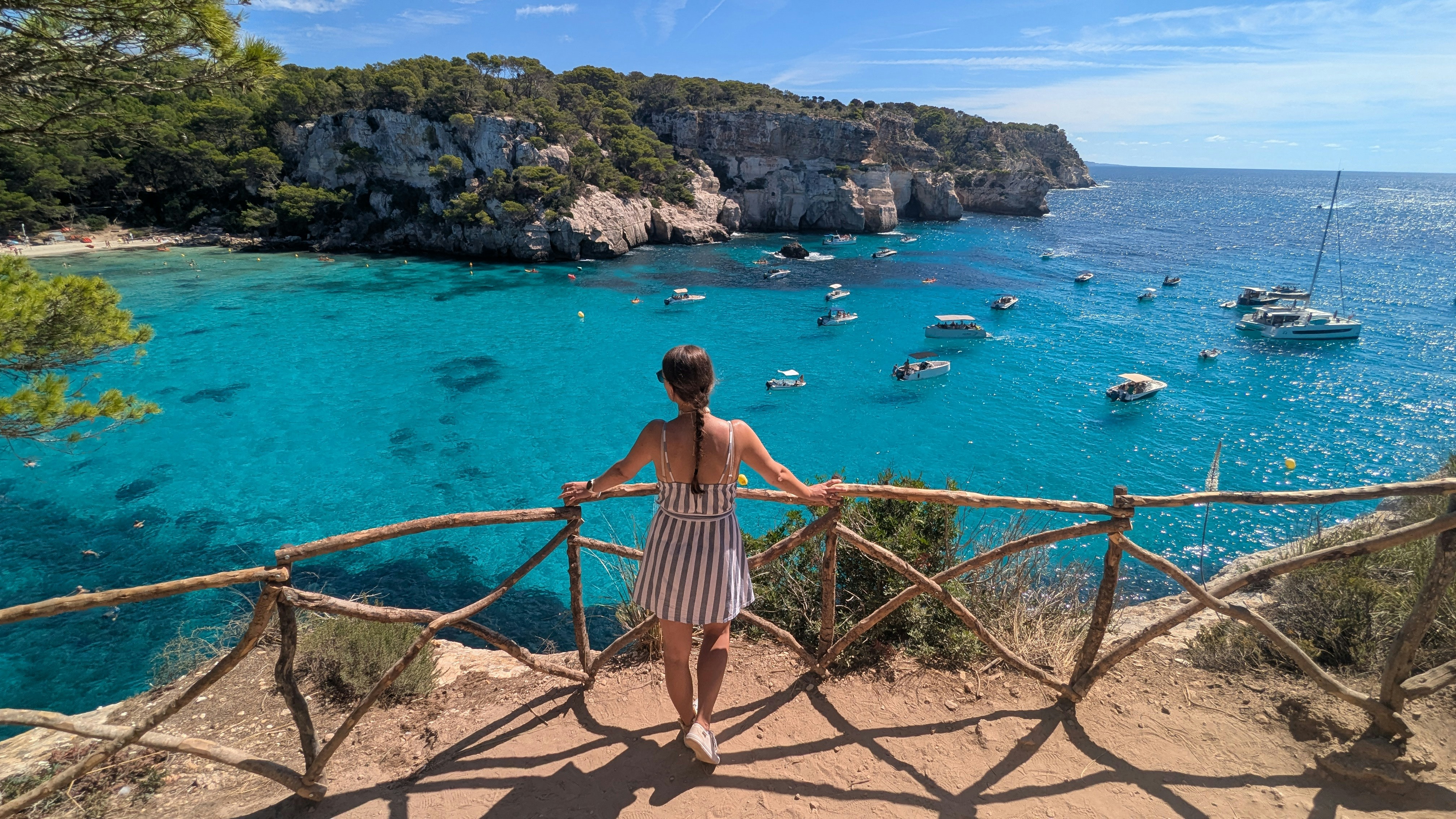 Cliffside Pose: A Solitary Moment Over A Turquoise Cove