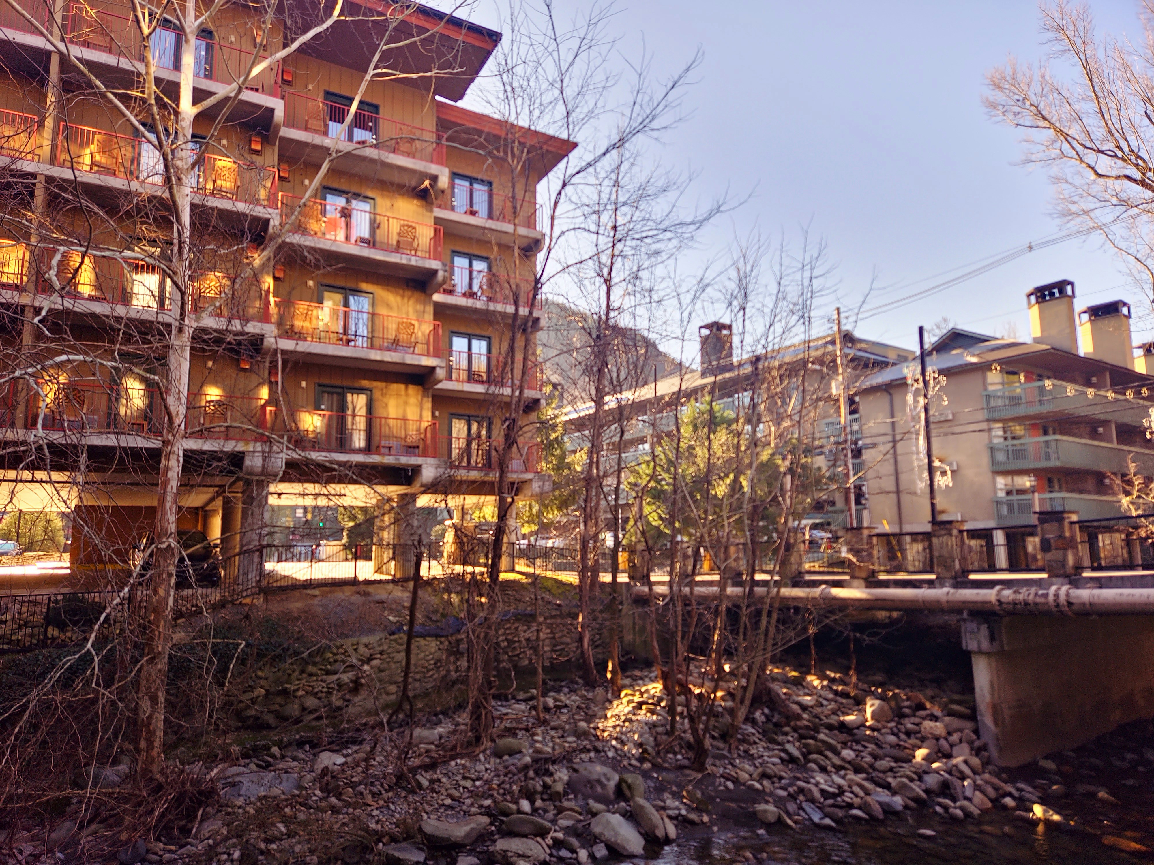 Sunlit Lakeside Village: Warm Glow on Wooden Facades