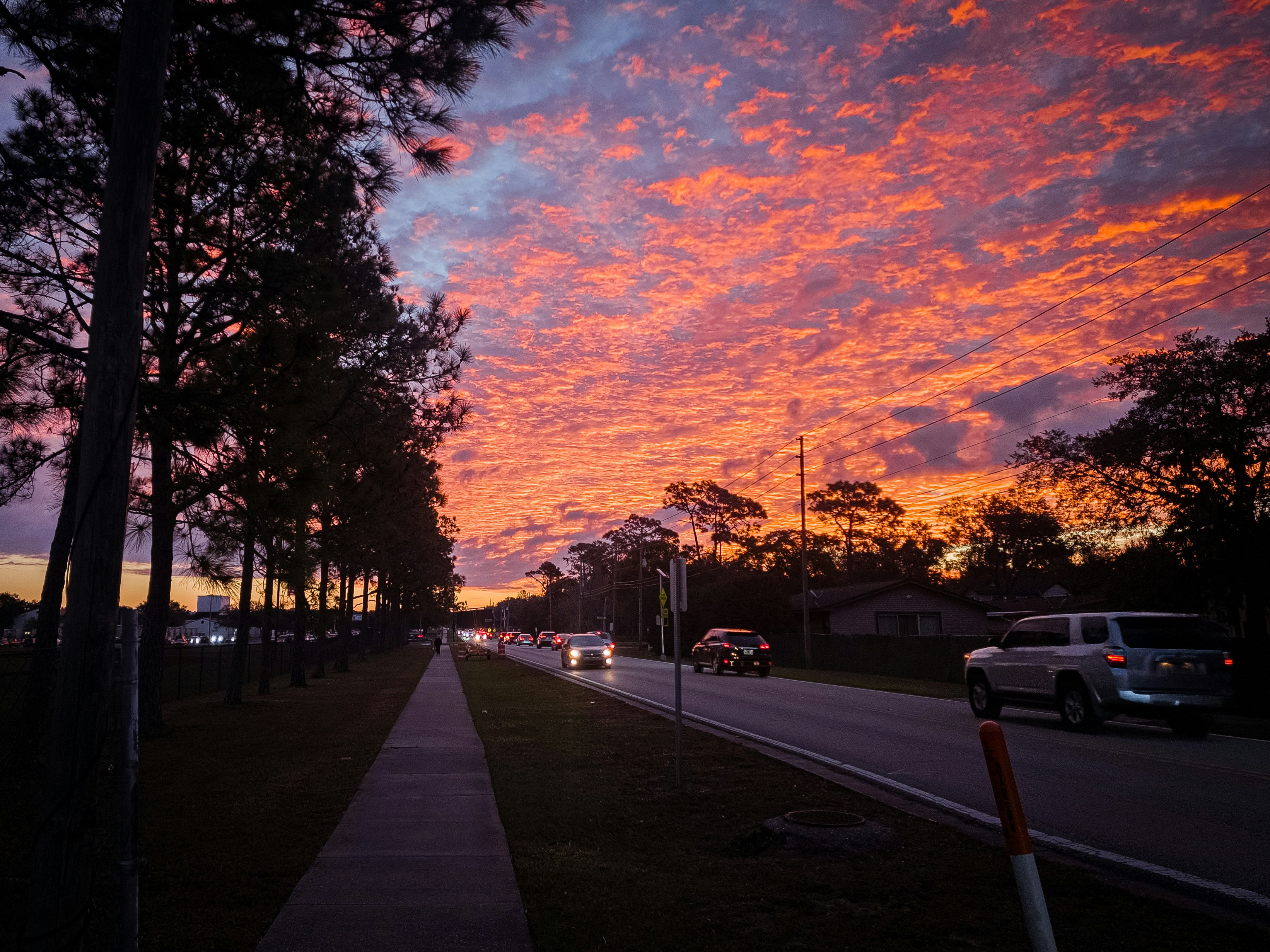 Sunset Street: Crimson Clouds Over a Quiet Suburban Road
