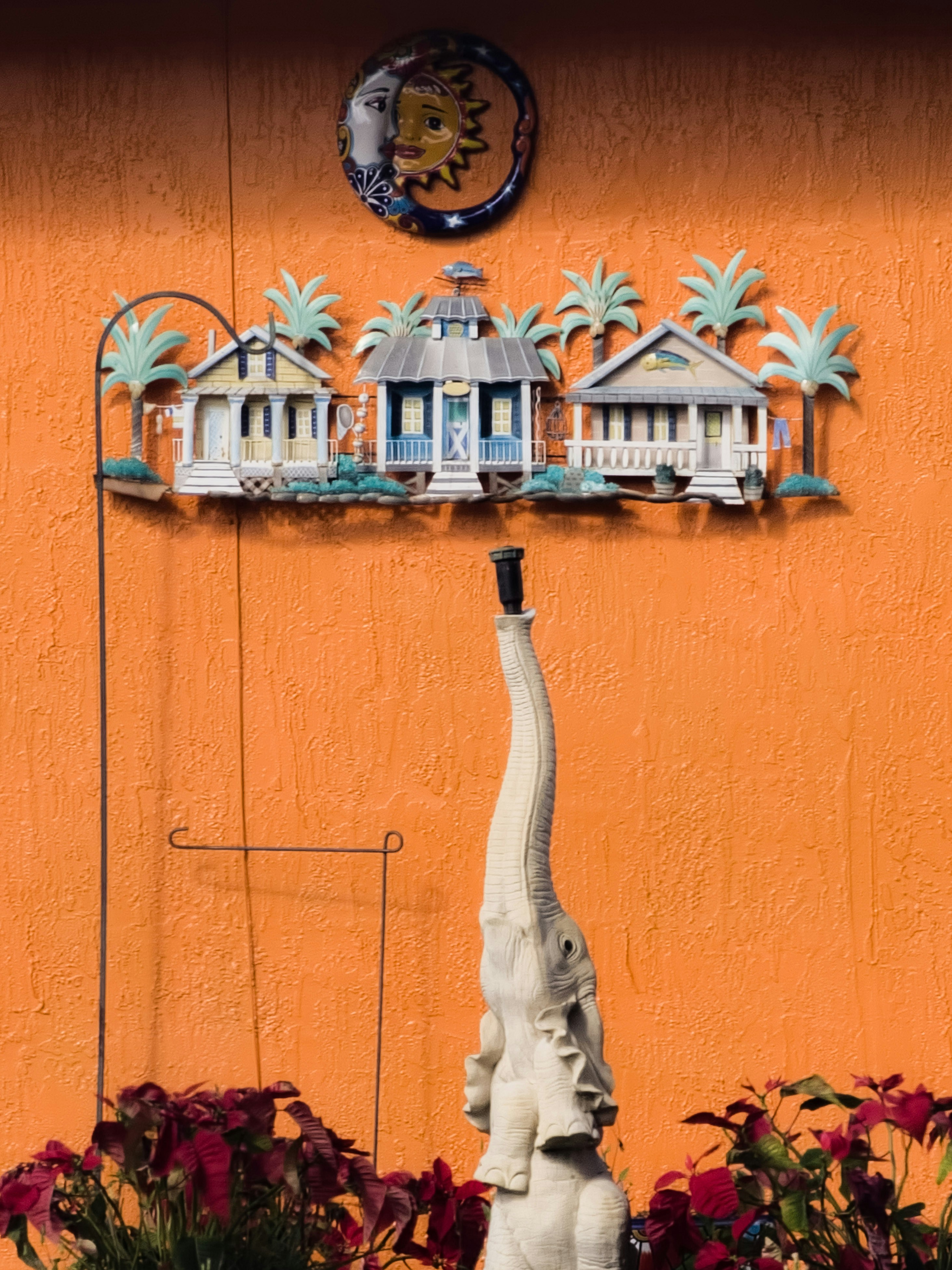 Orange Facade, Miniature Village, and Giraffe-like Monument