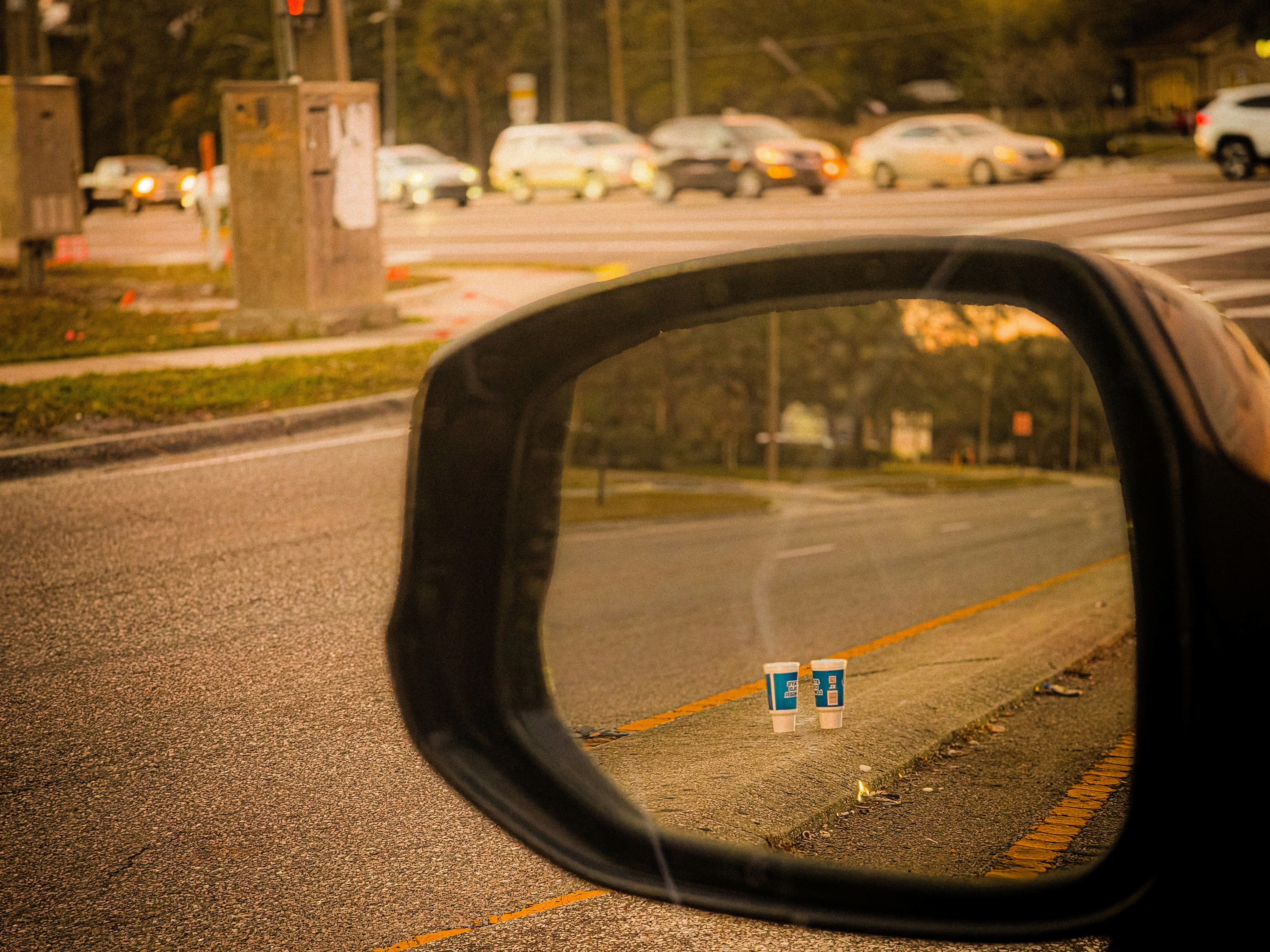 Side-View Mirror: Street Scene Reflected in a Car’s Side Glass