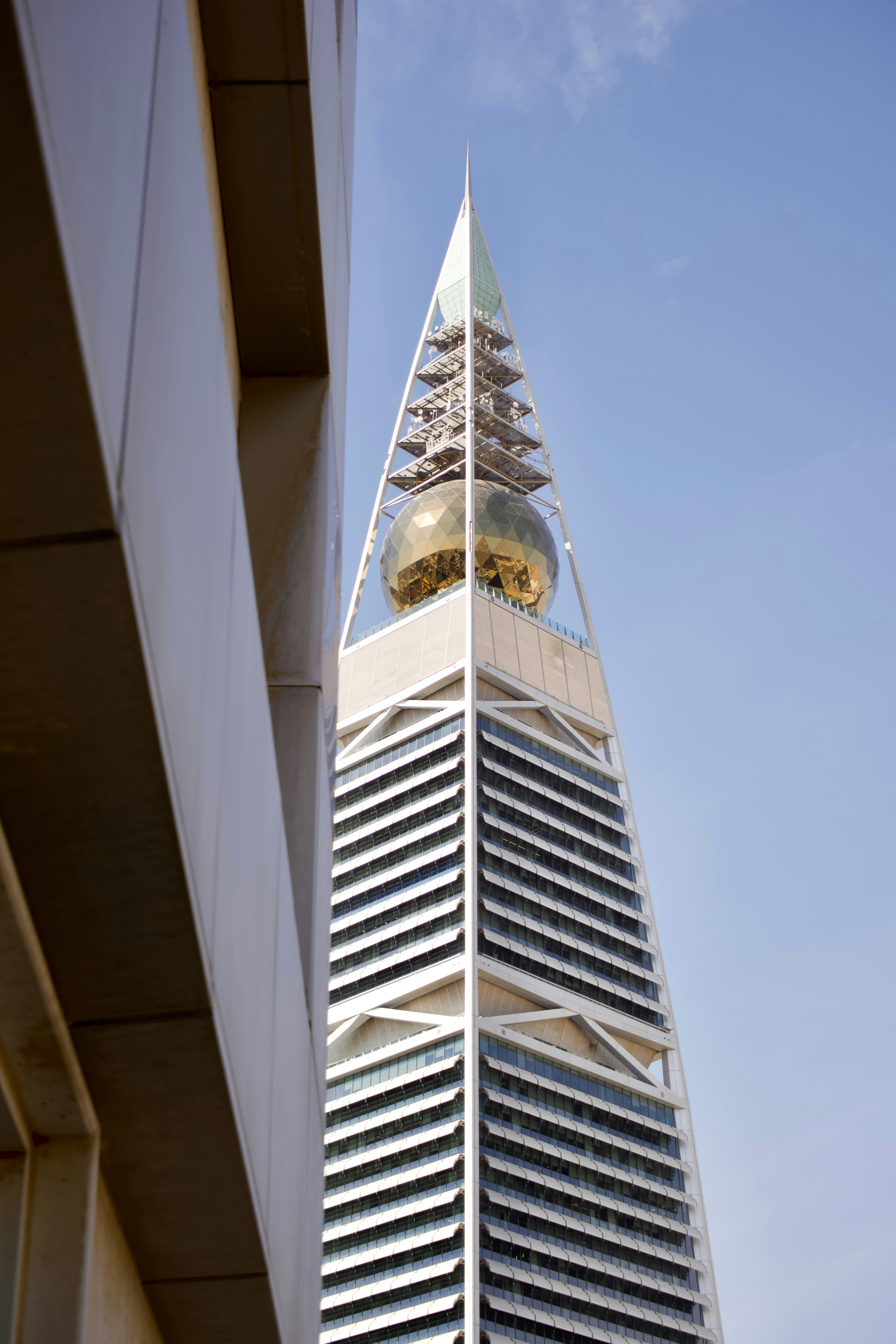 Spire and Sphere: A Towering Pinnacle Piercing a Clear Sky