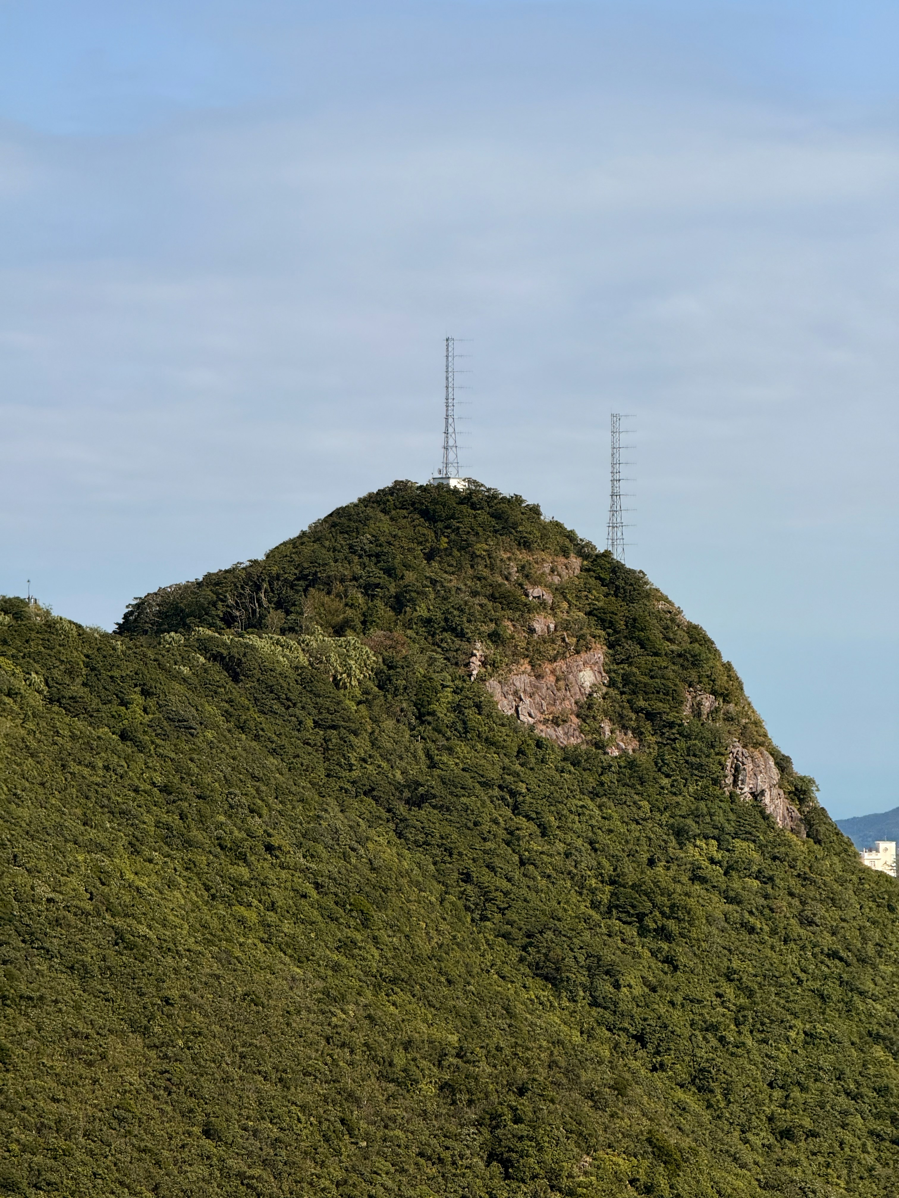 Peak Sentinel: Radio Towers Crown the Green Summit