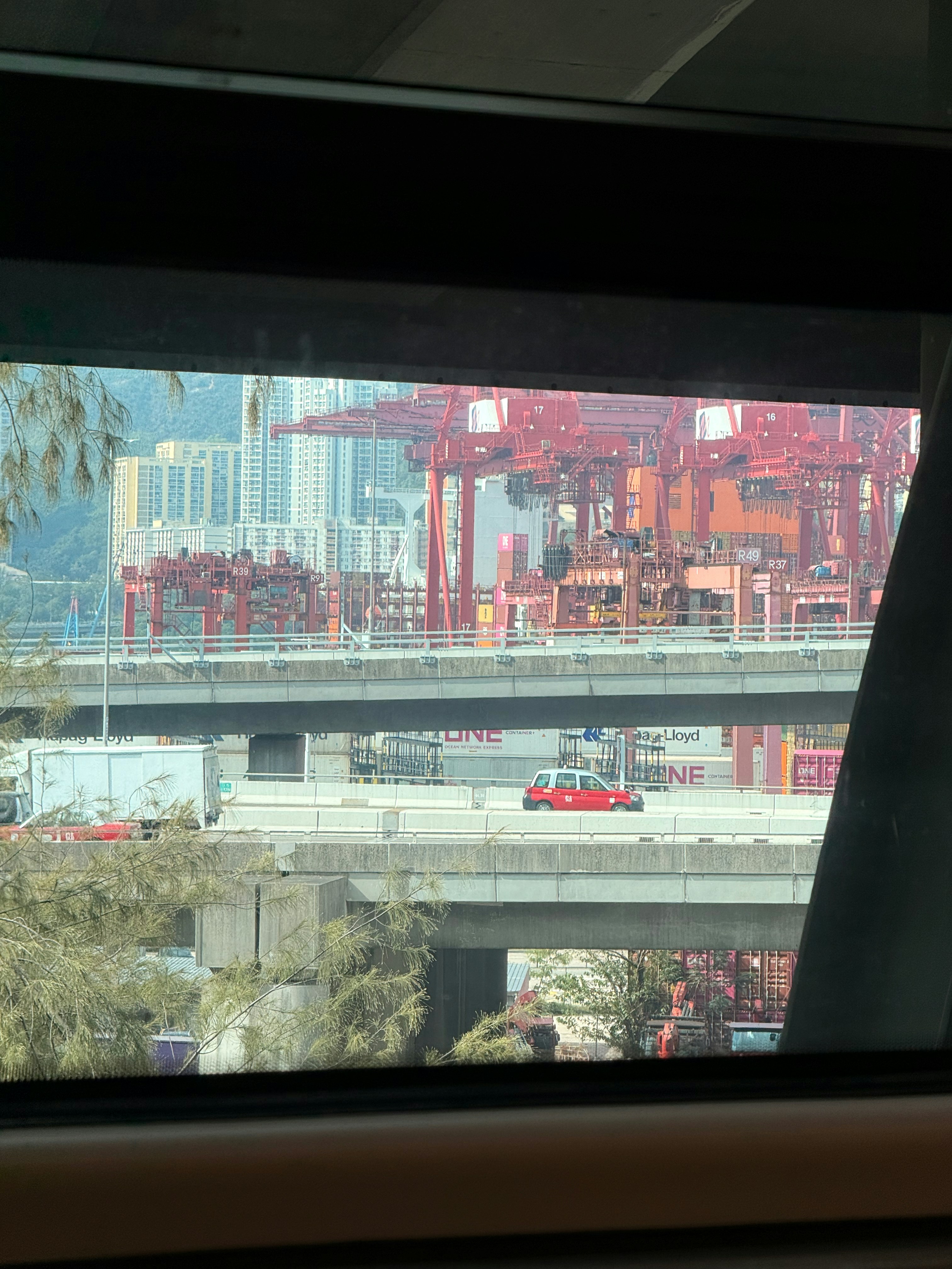 Urban Freight Corridor Framed by Overpass and Container Cranes