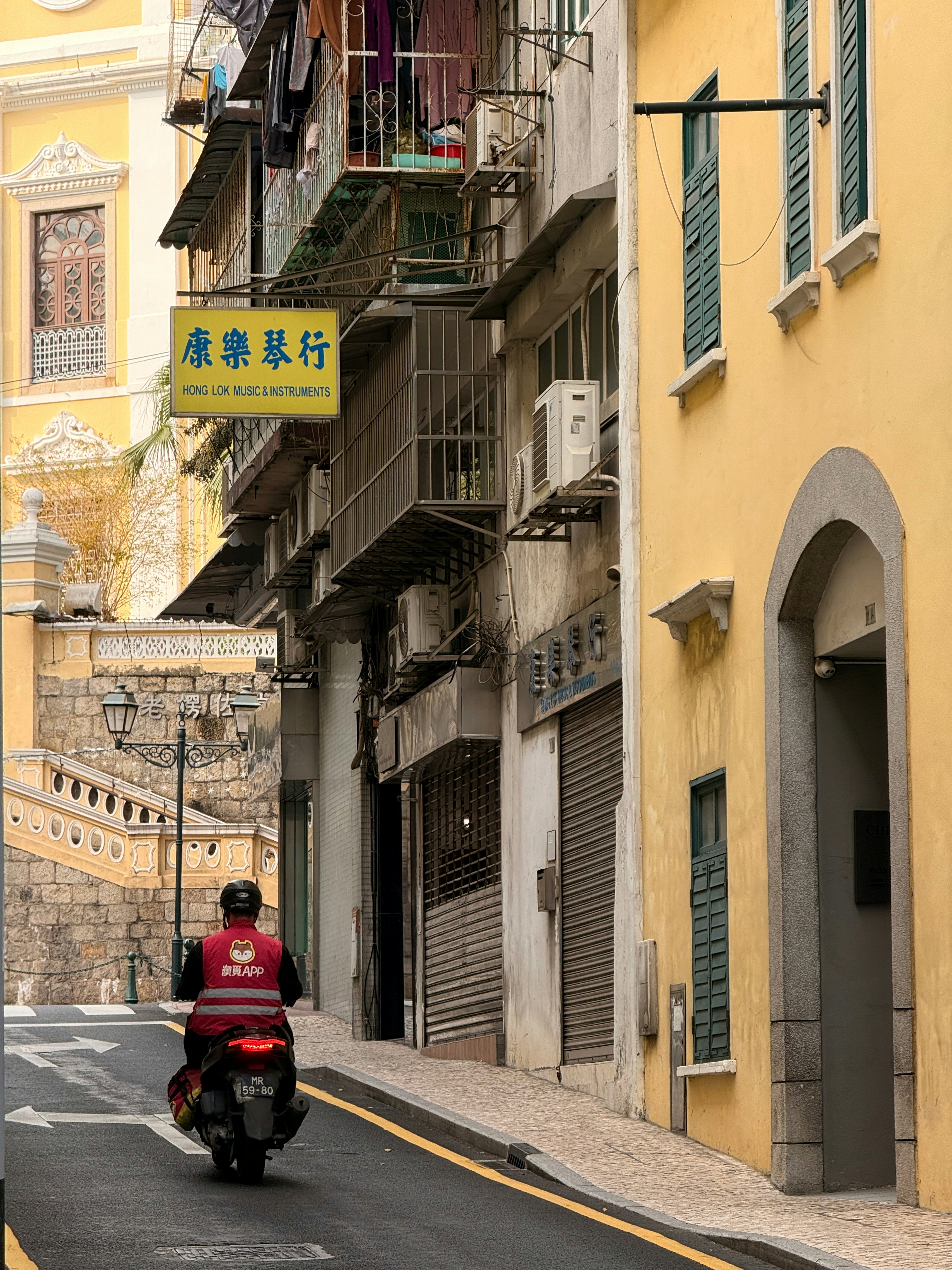 Scooter Descent Through a Sunlit Alley