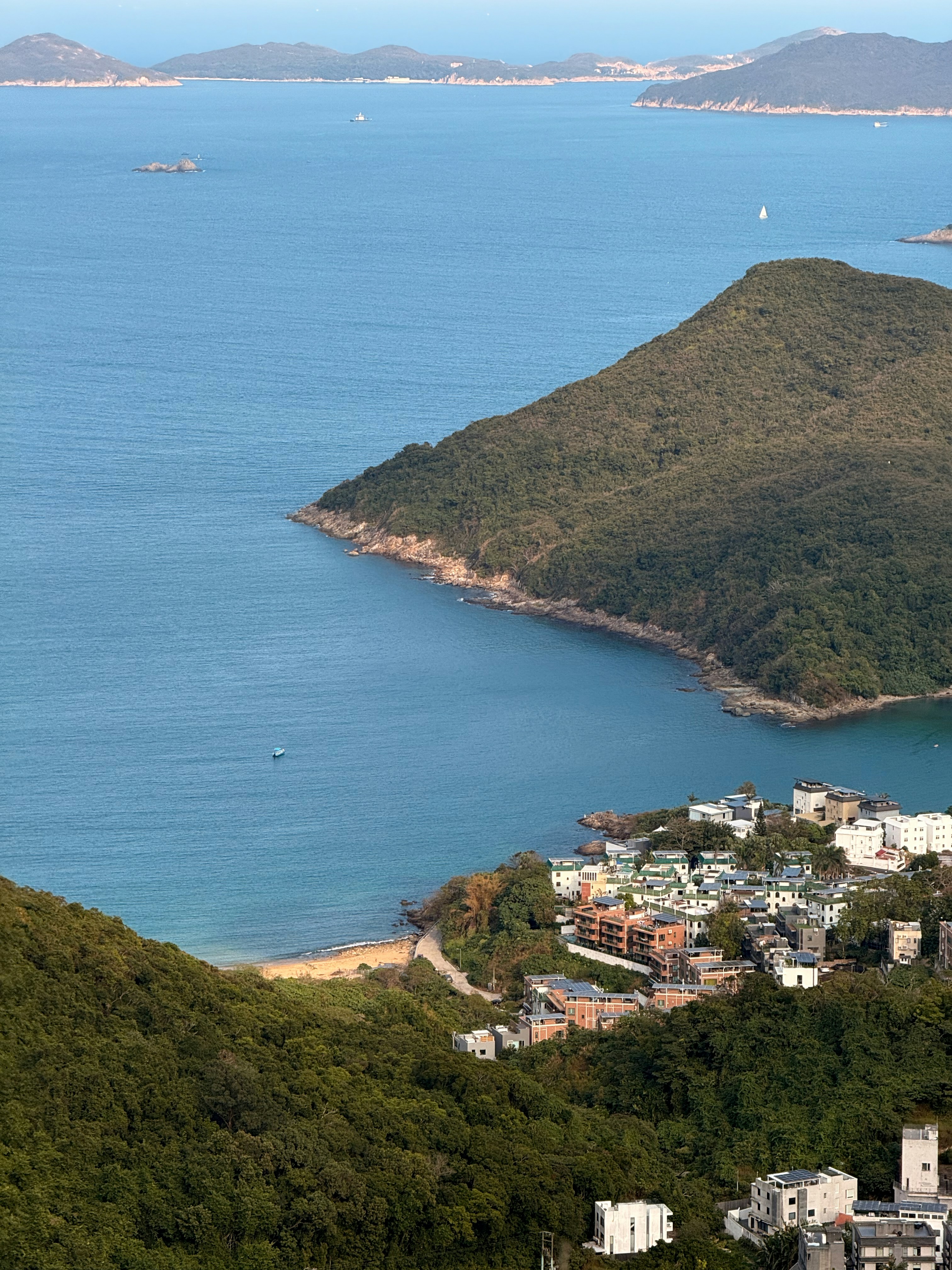 Harbor Village Nestled Between Forested Hills and Blue Expanse