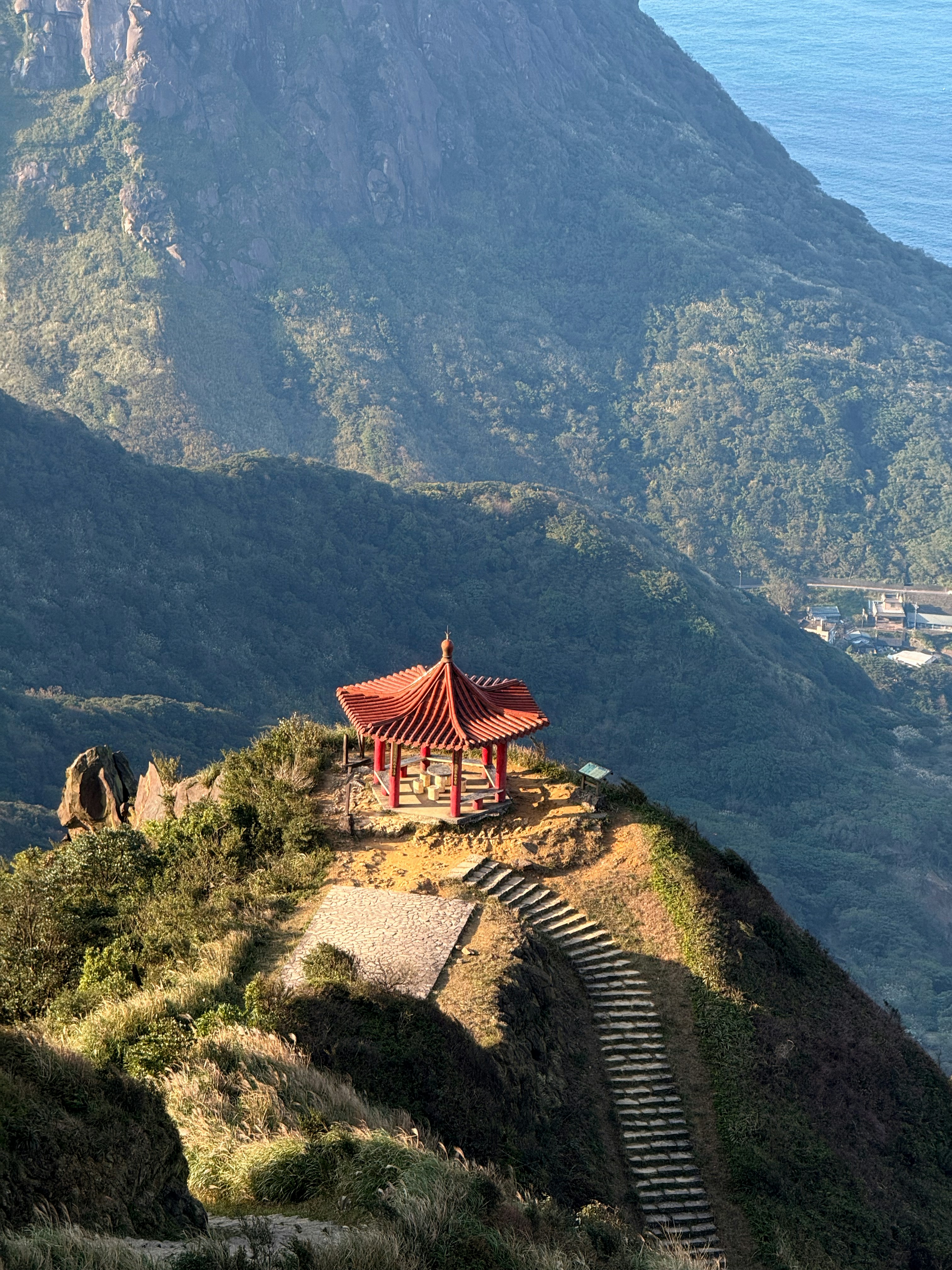 Red Pavilion on the Cliff: A Quiet Horizon Above the Sea