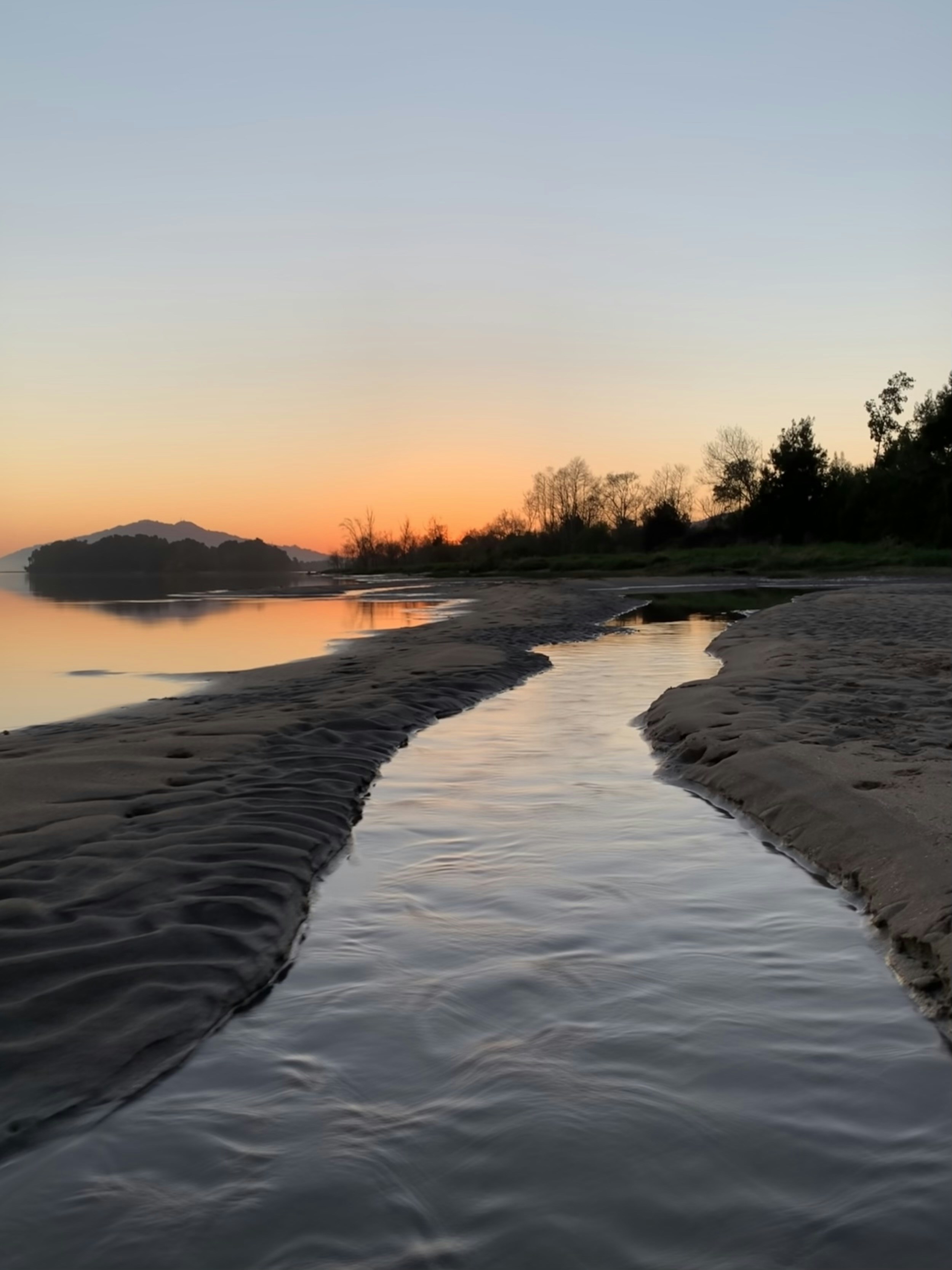 Silent Tide at Sunset: A Sandbar Pathway Reflects the Sky