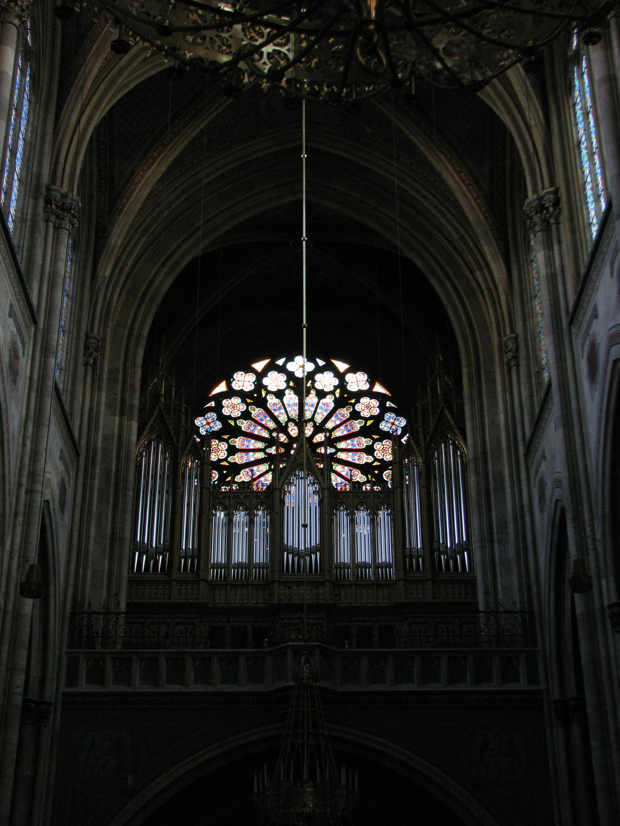 Gothic cathedral interior with a large stained glass window