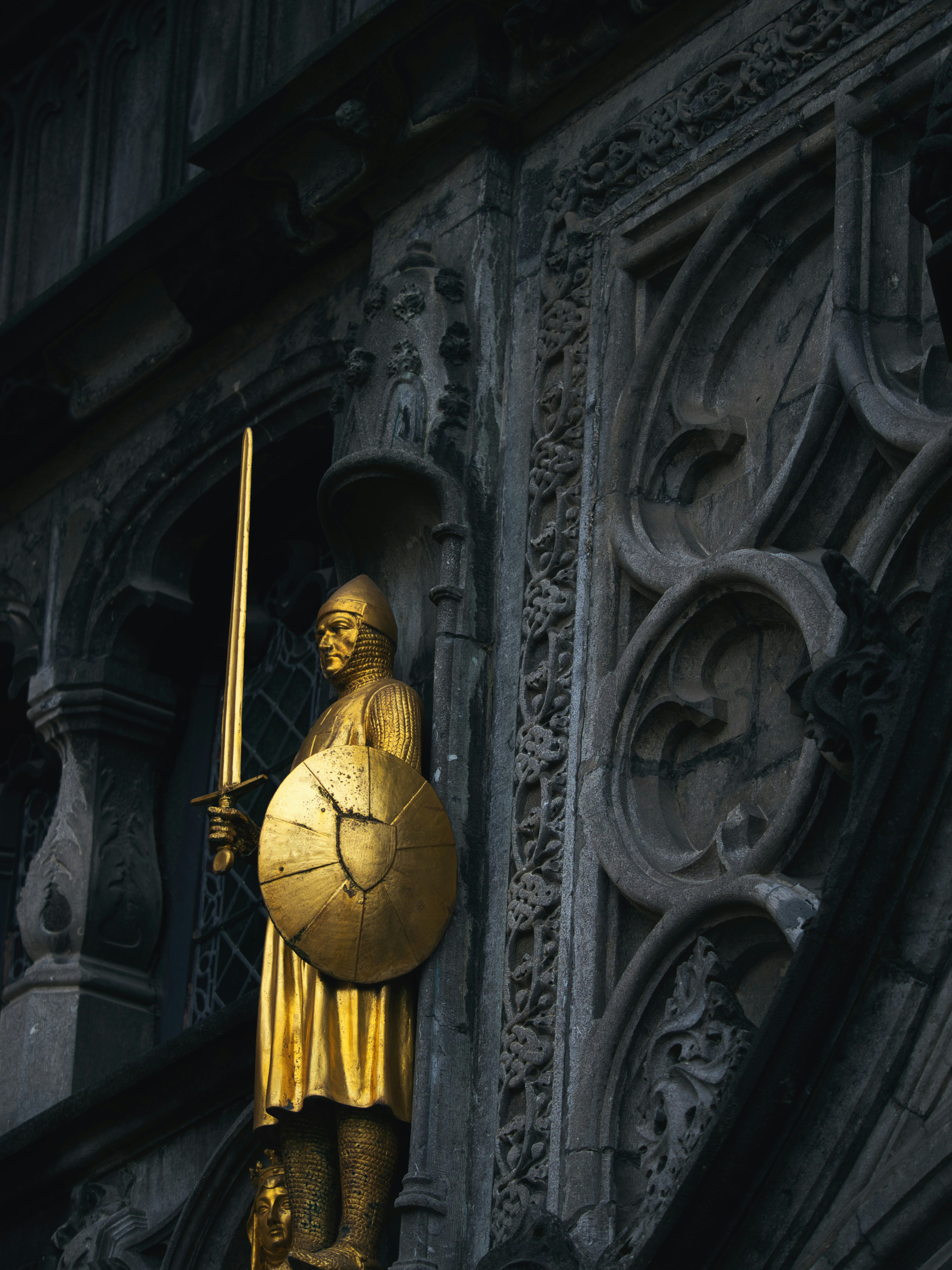 Golden Knight on the Gothic Facade