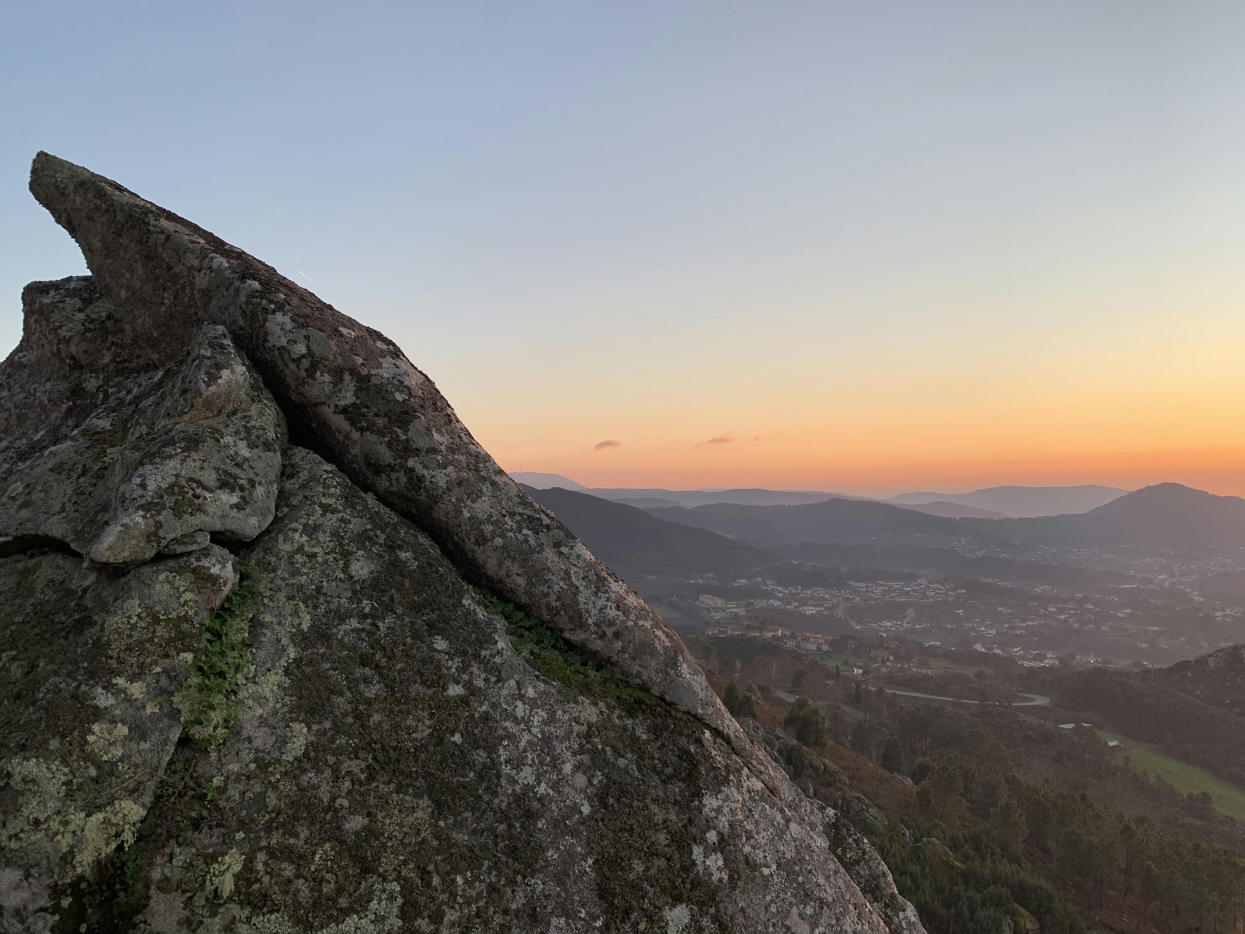Summit Wake: Sunlit Granite Overlooking a Valley at Dusk