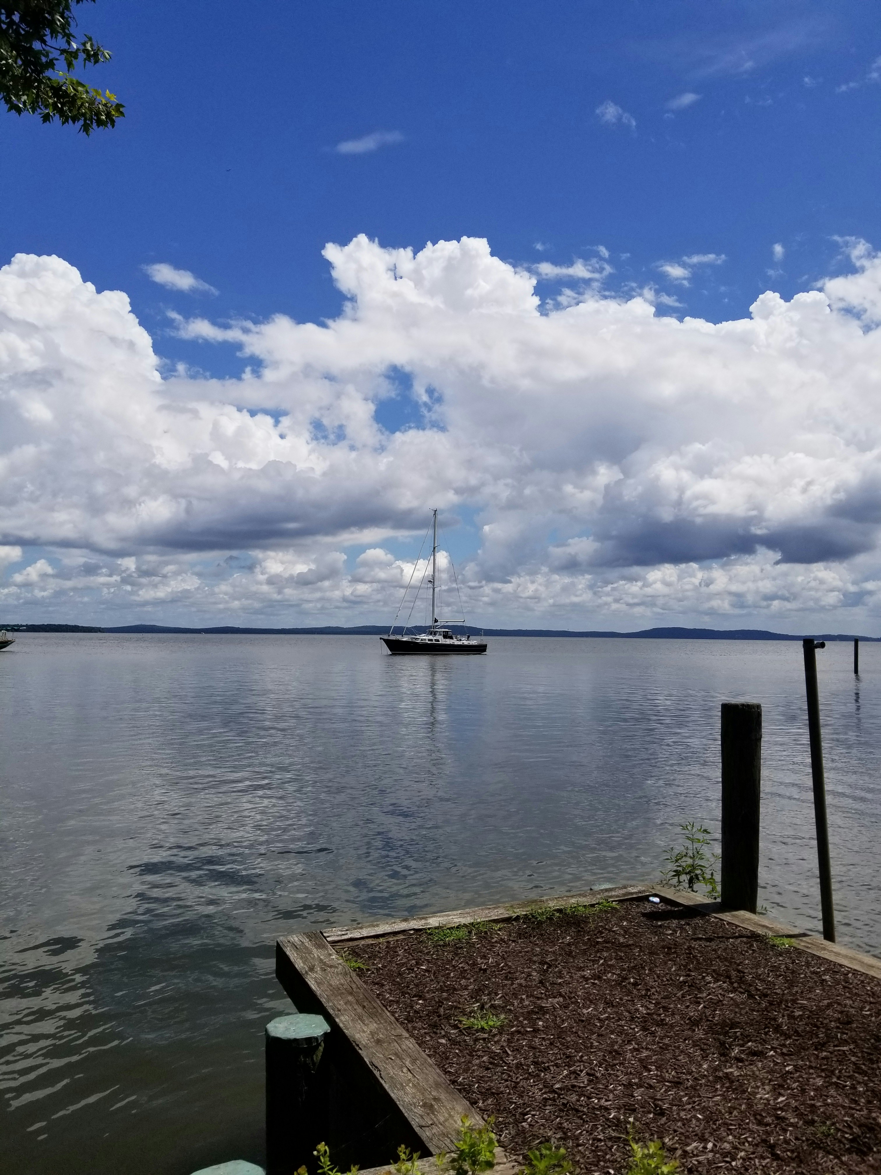 Sailboat at Distant Horizon on a Quiet Lake