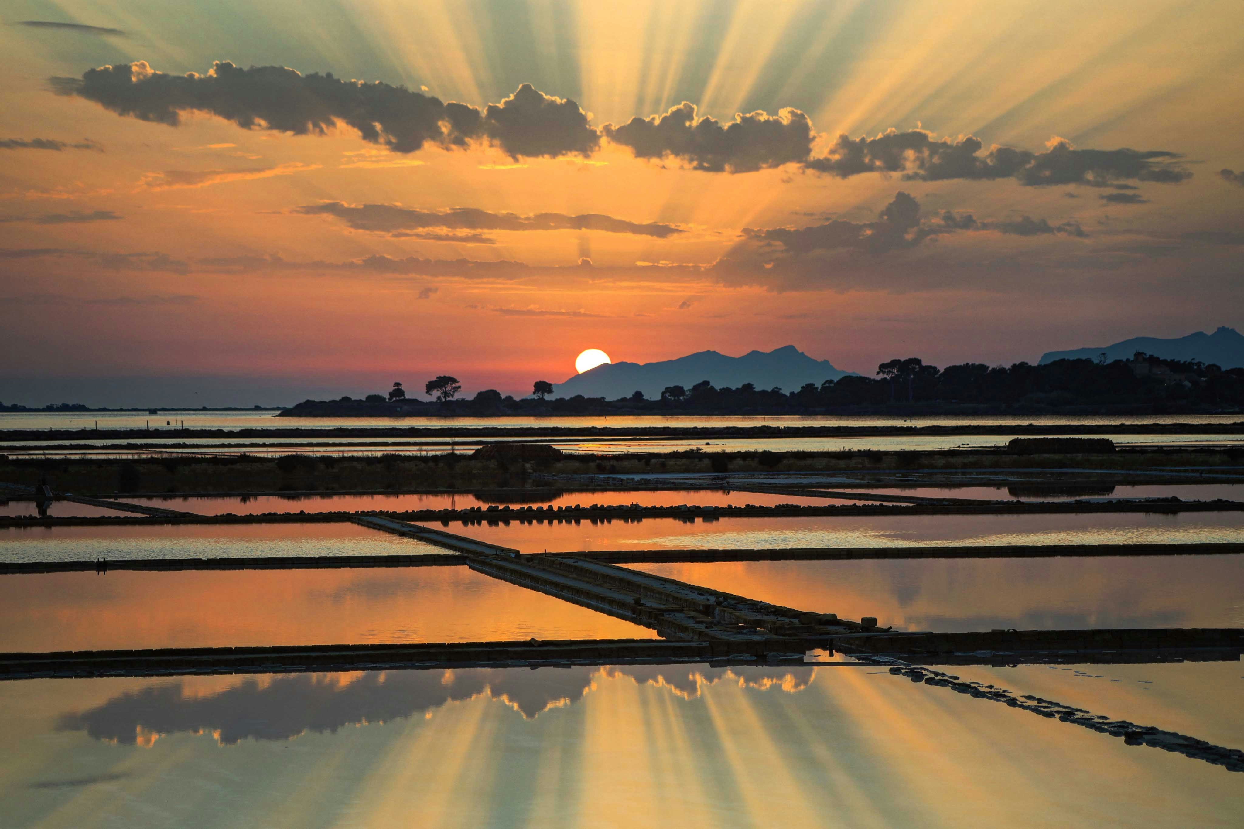 Sunrise over Tidal Lines: Reflective Salt Flats become Golden Rolds