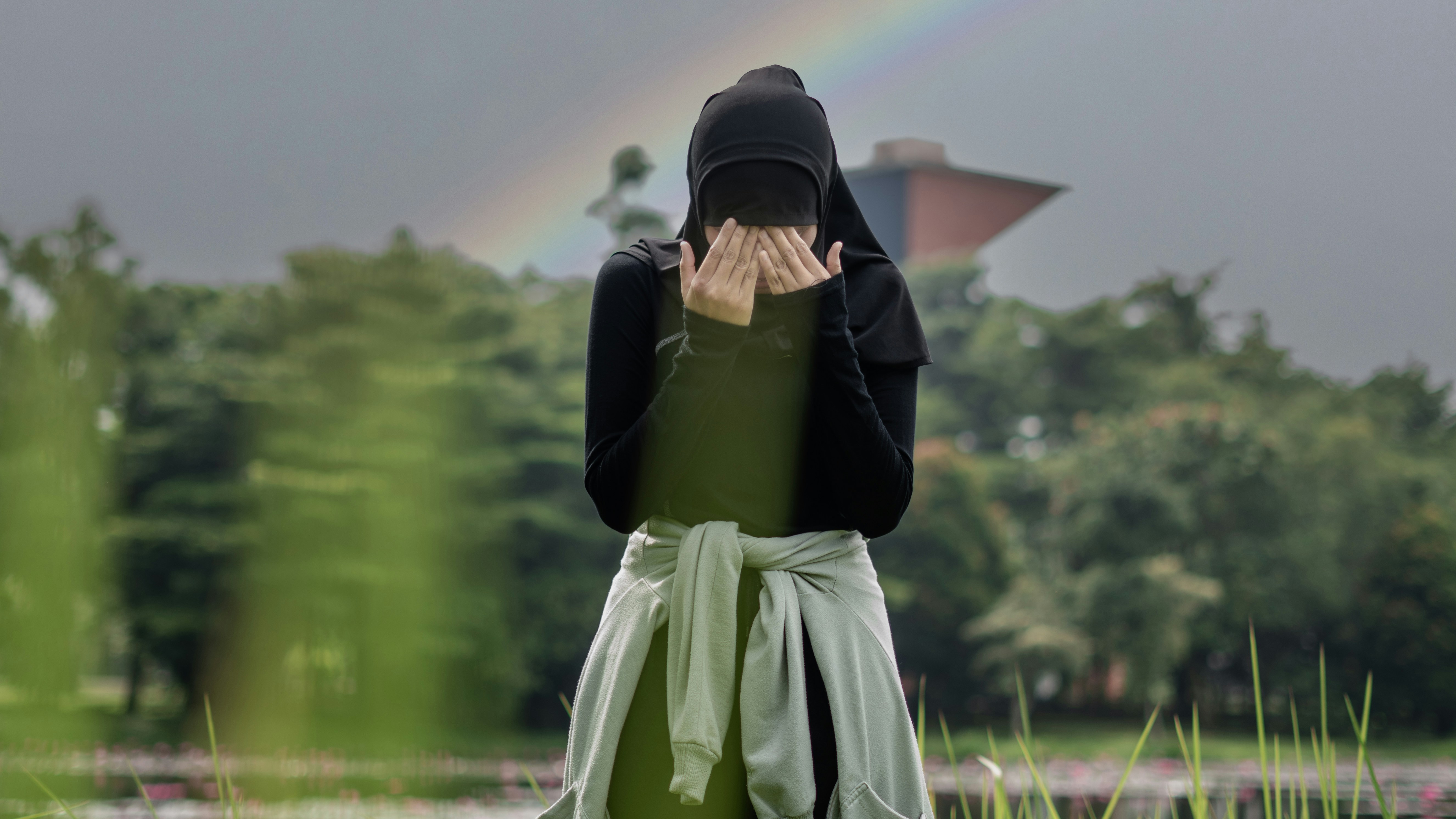 Behind the Veil: A Portrait of Quiet Candidness Under a Rainbow