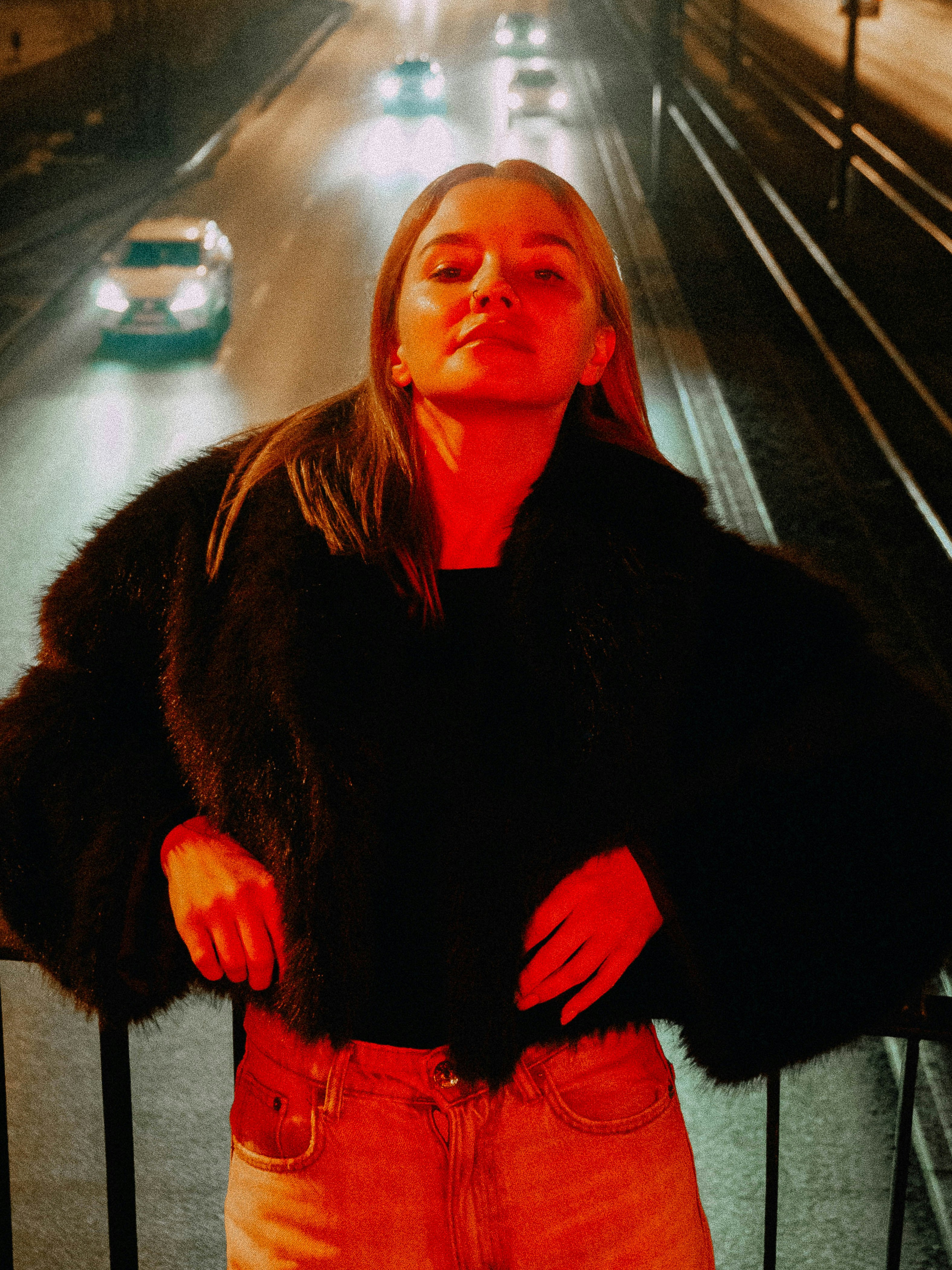 Urban glow: confidence under red streetlamp