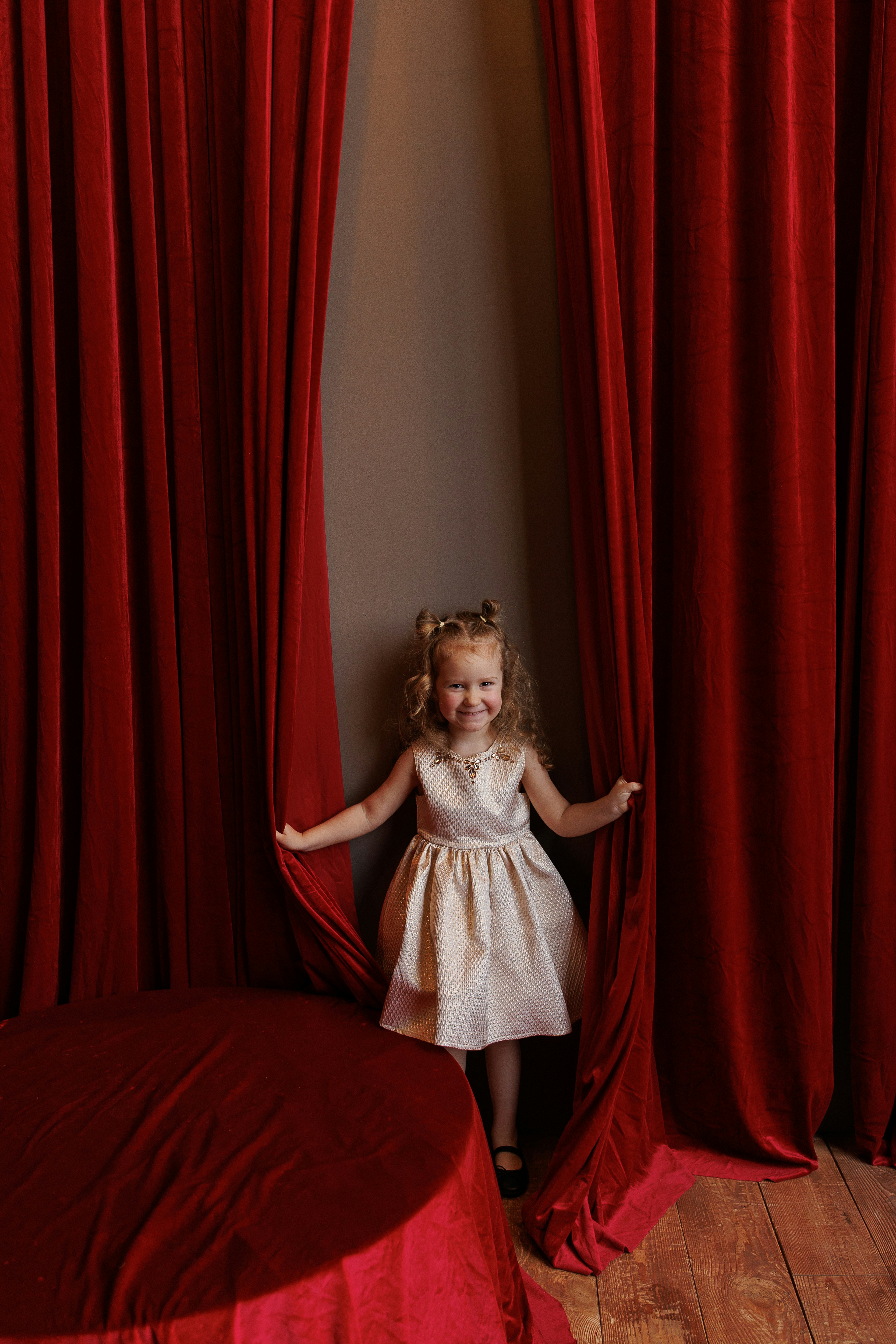 Curtain Call: A Tiny Star Emerges Through Velvet Drapes