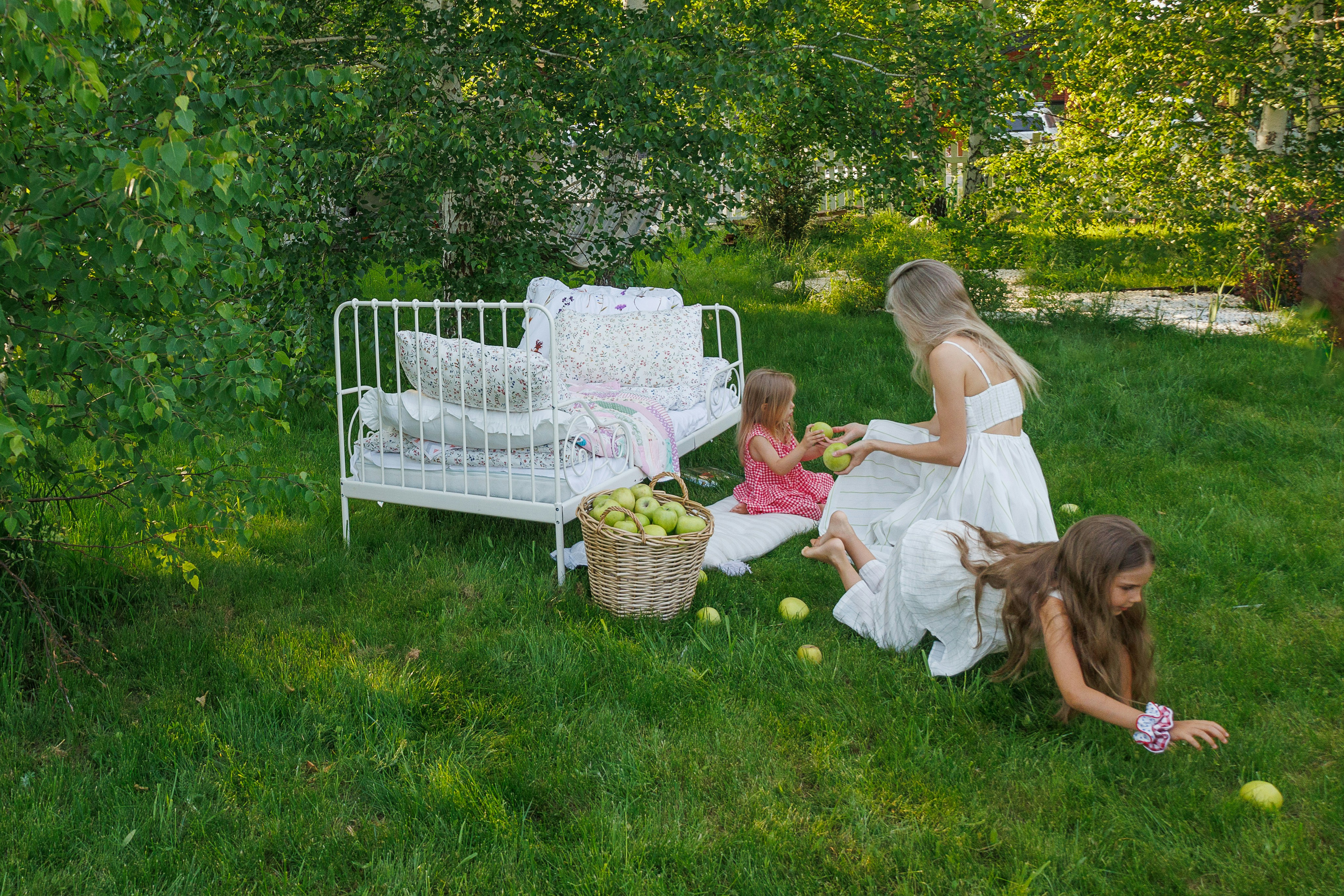 Sunlit Orchard Tea Party: Sisters and a Basket of Apples