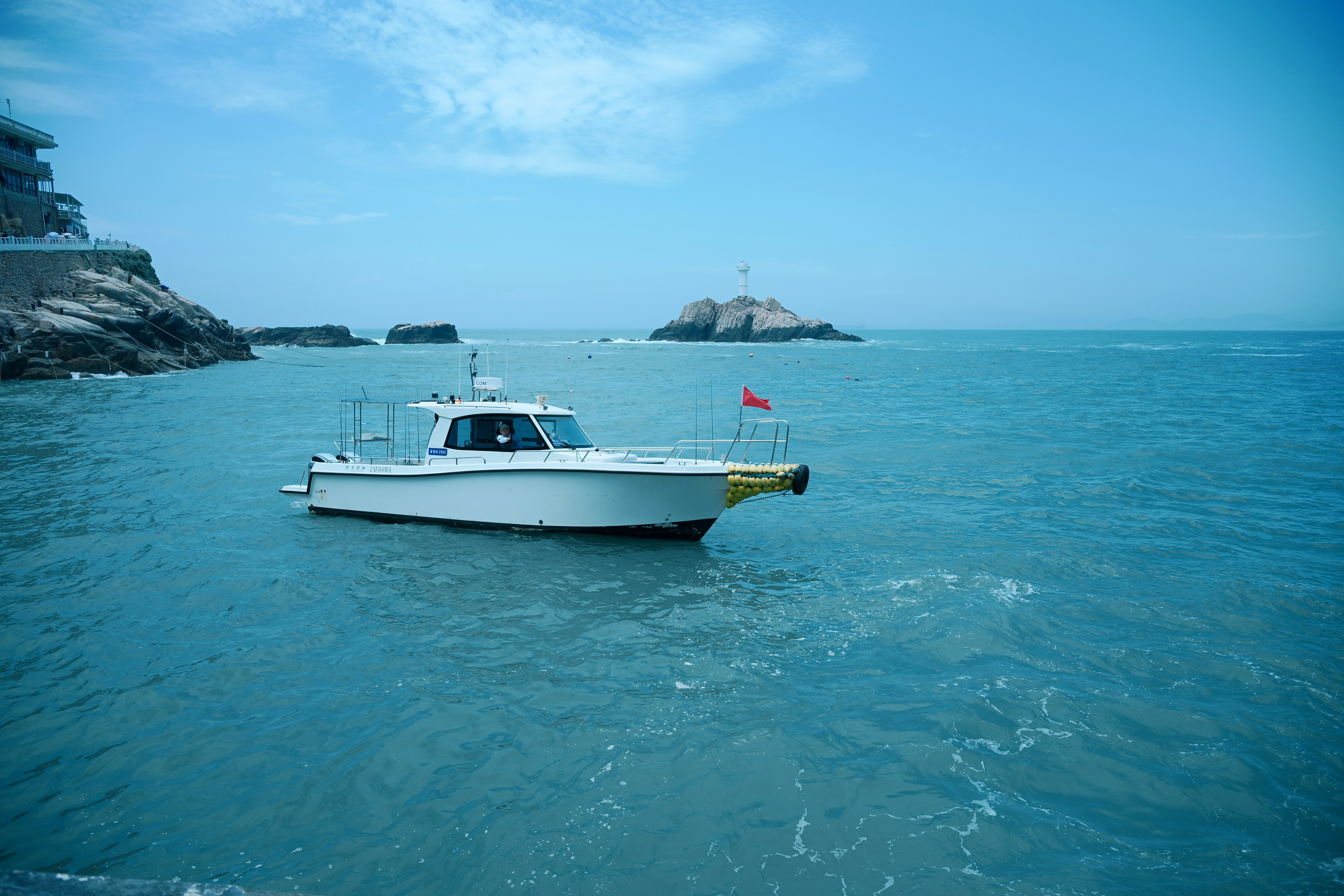 Boat in Calm Turquoise Waters Near a Small Island