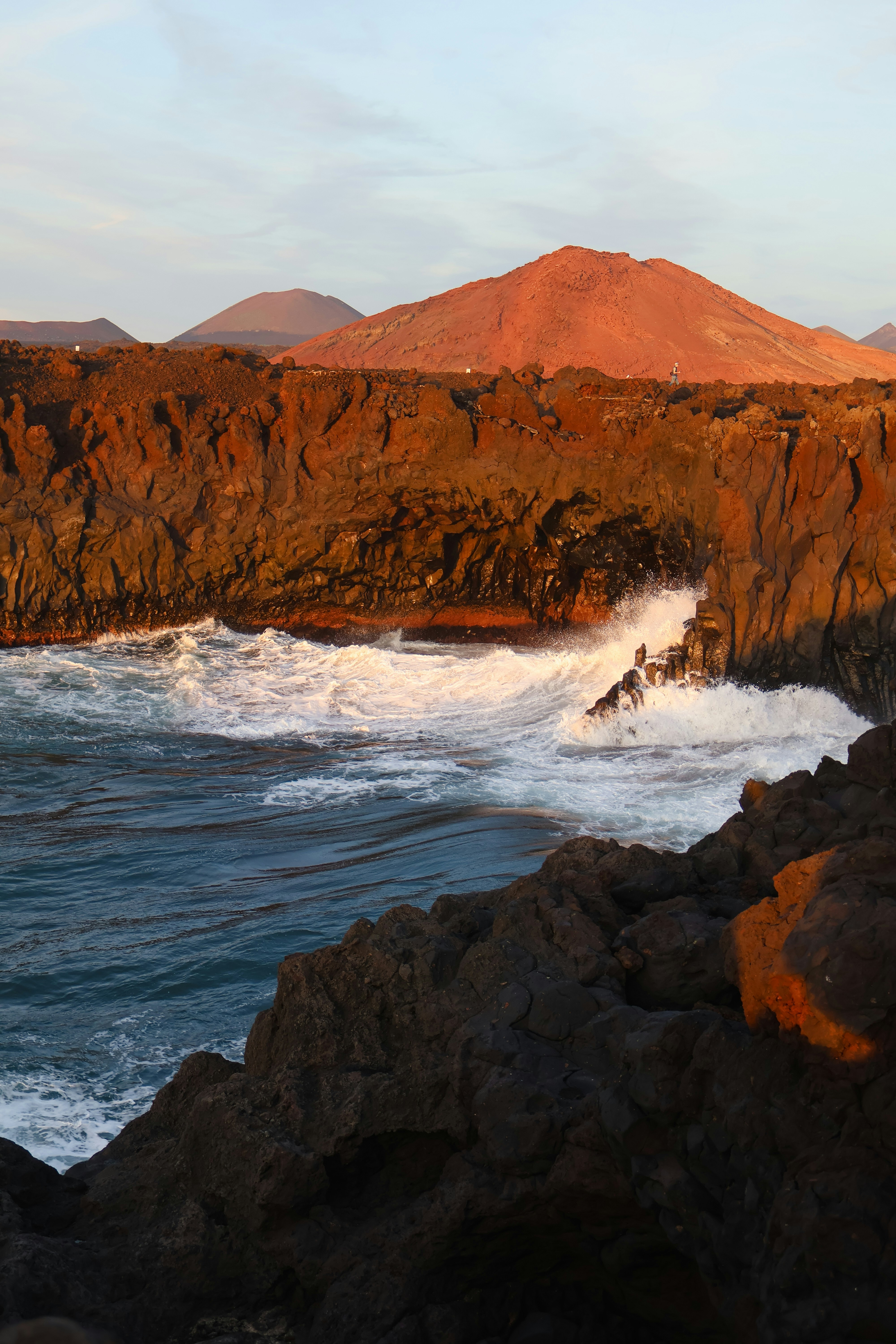 Crimson Cliffs and Surging Tide at Dusk