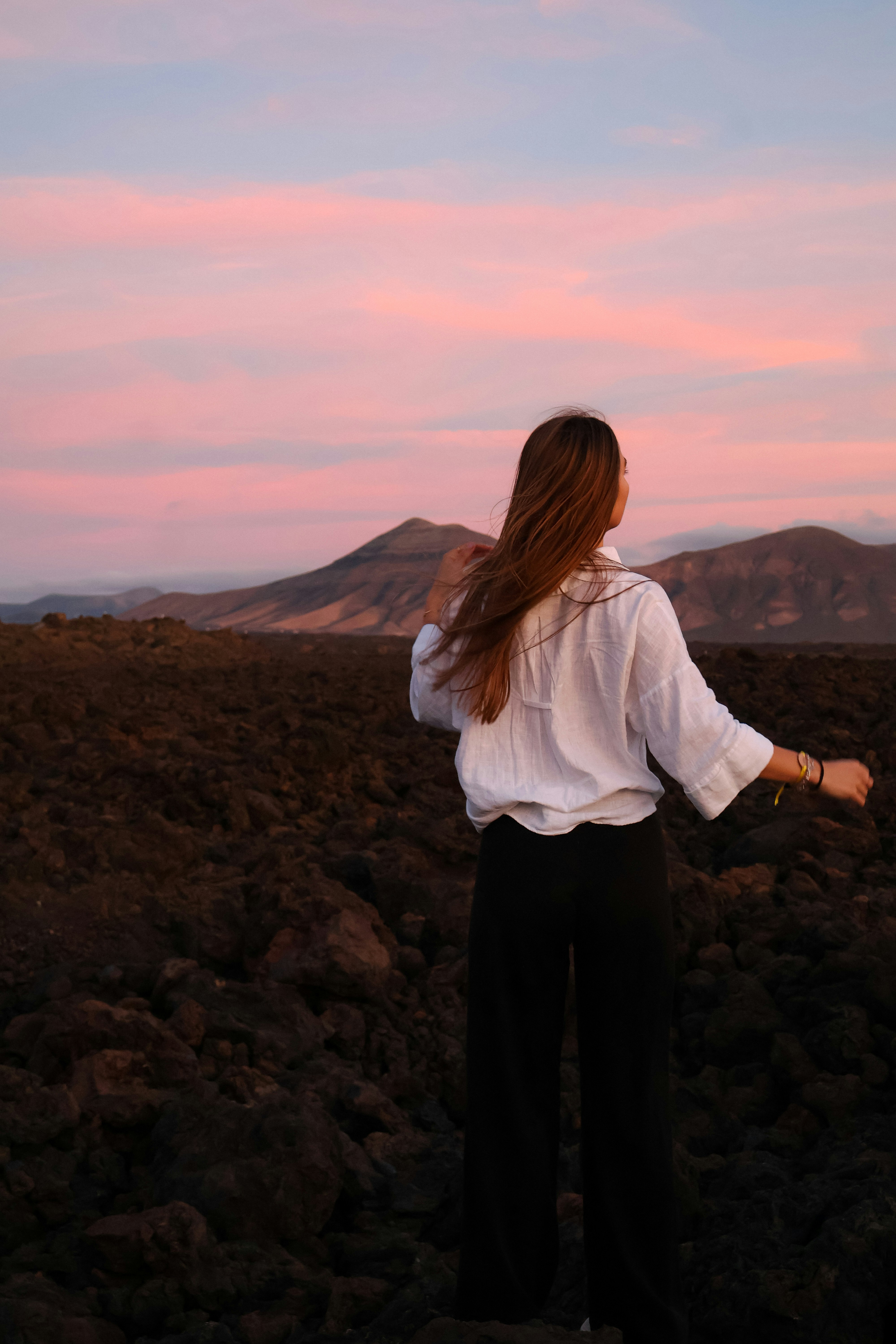 Silhouette of a Wanderer Against a Lava Field Sunset