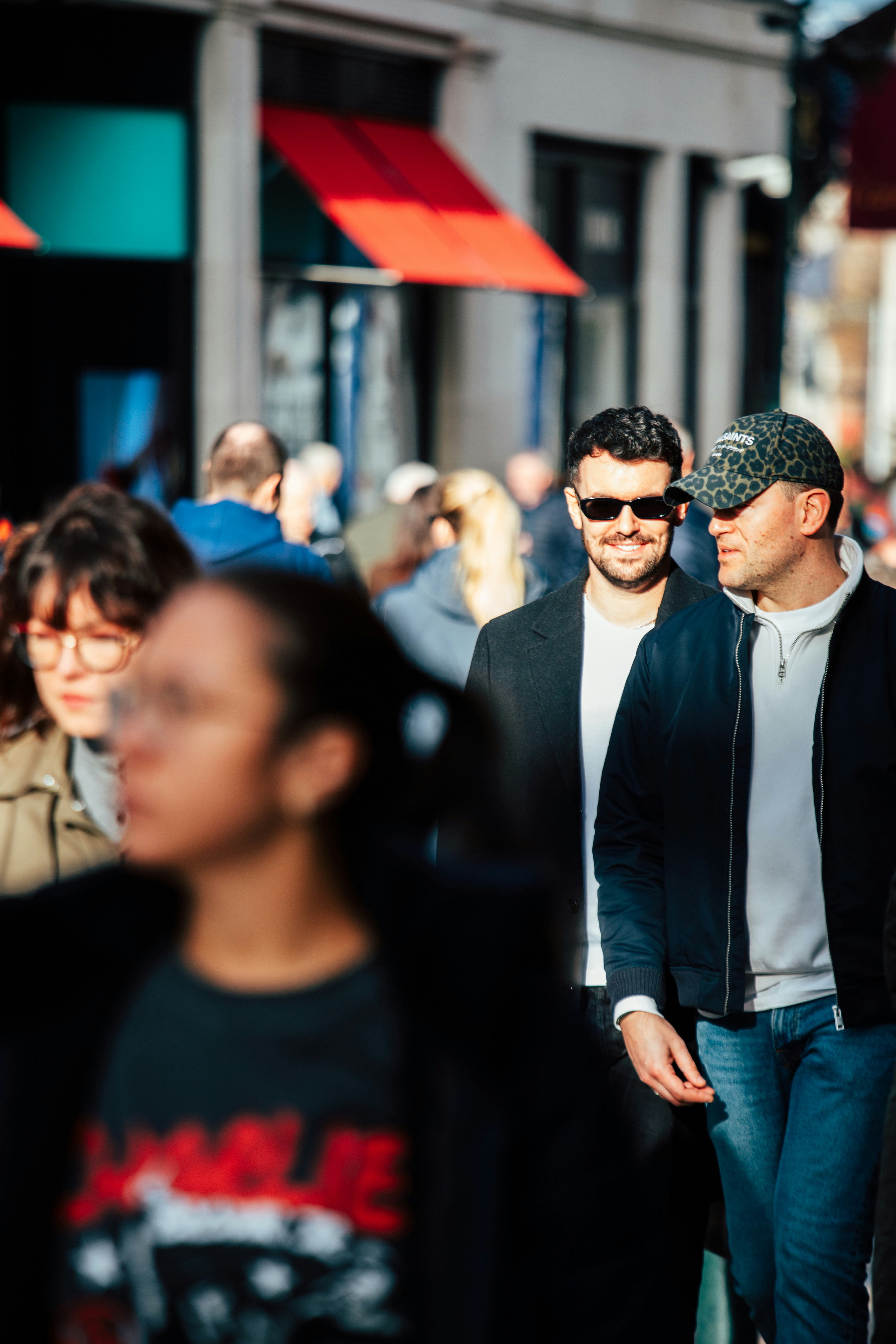 Midday City Pulse: Men in Conversation Amid the Crowd