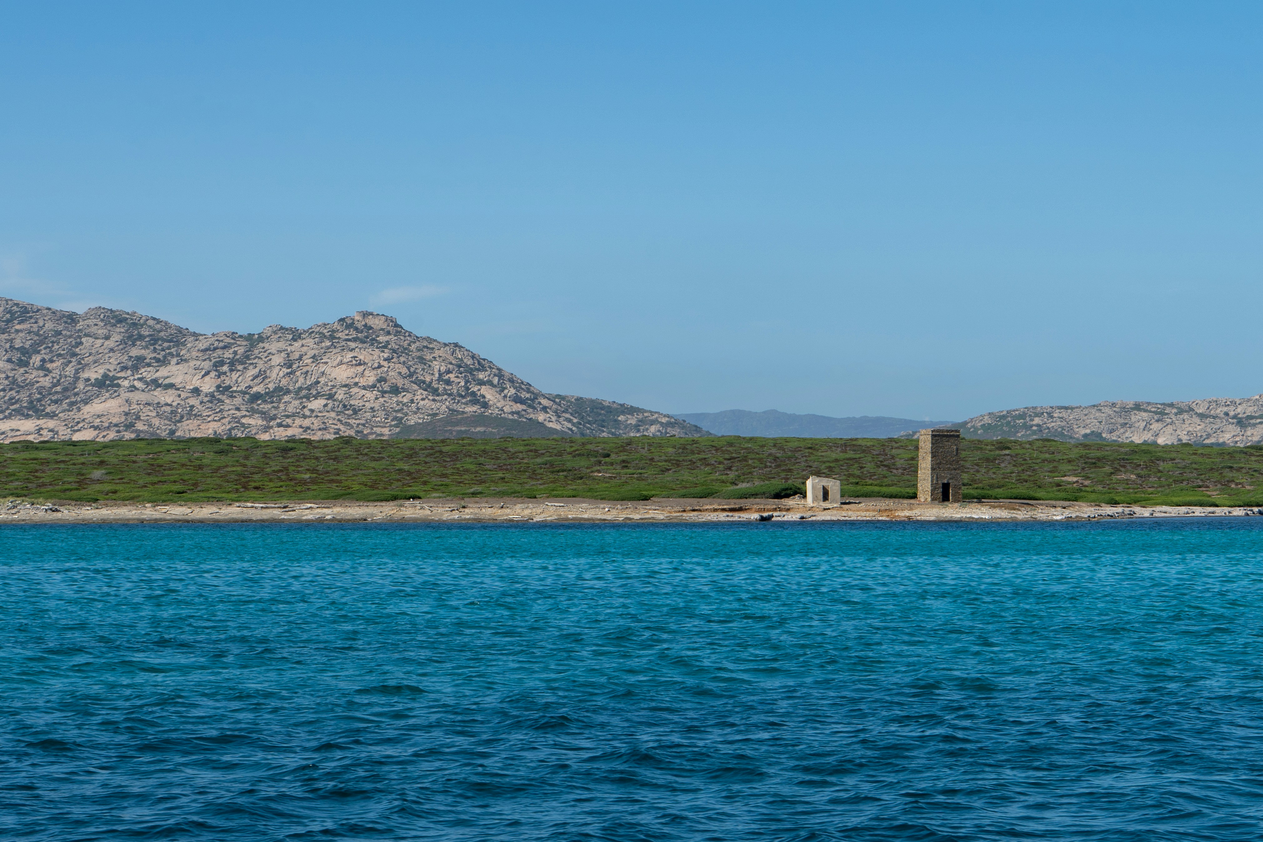 Coastal Turquoise Waters Meet Arid Hills and a Historic Pier