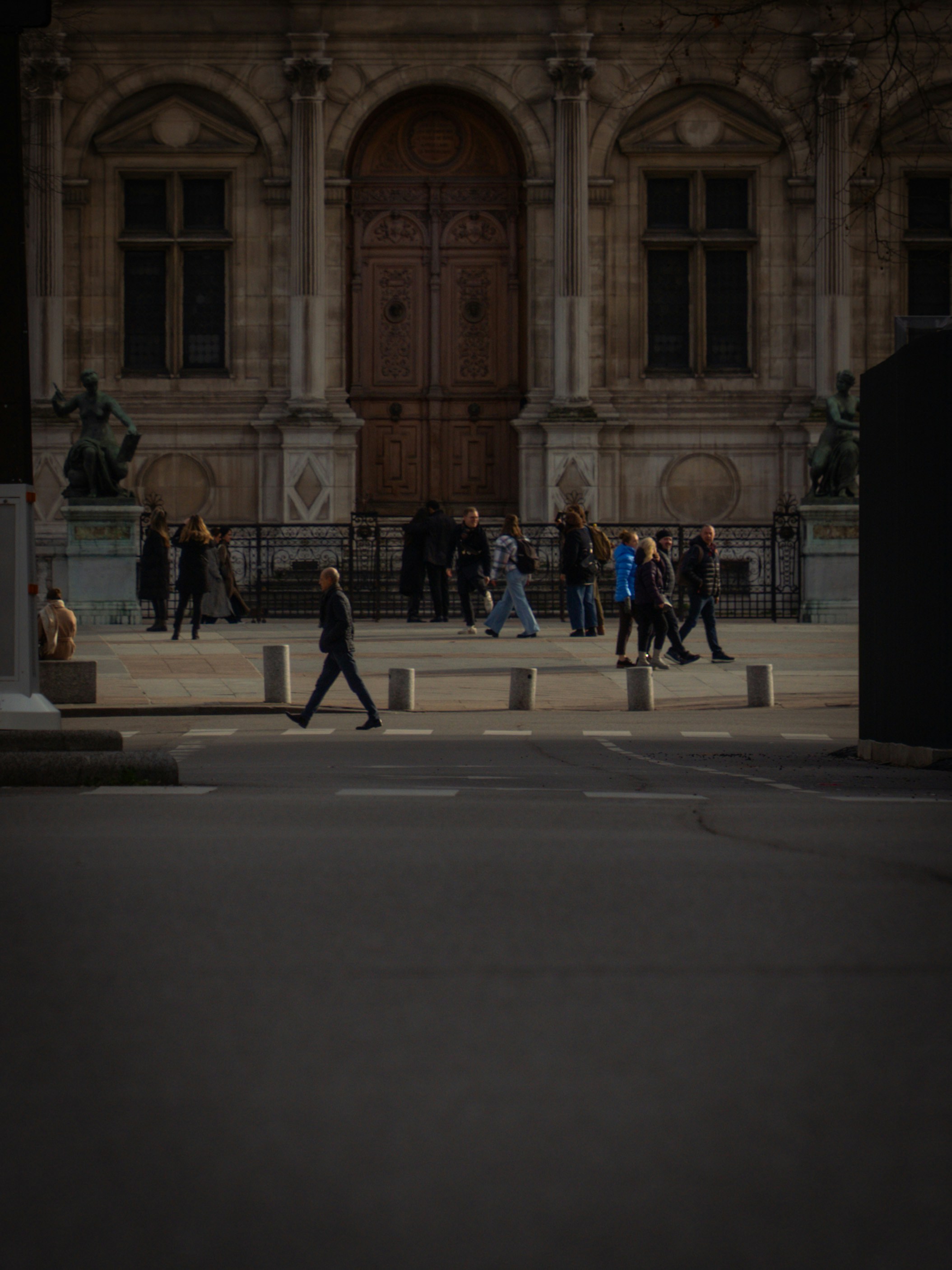 Footsteps Across the Facade: Morning Crowd in Forecourt