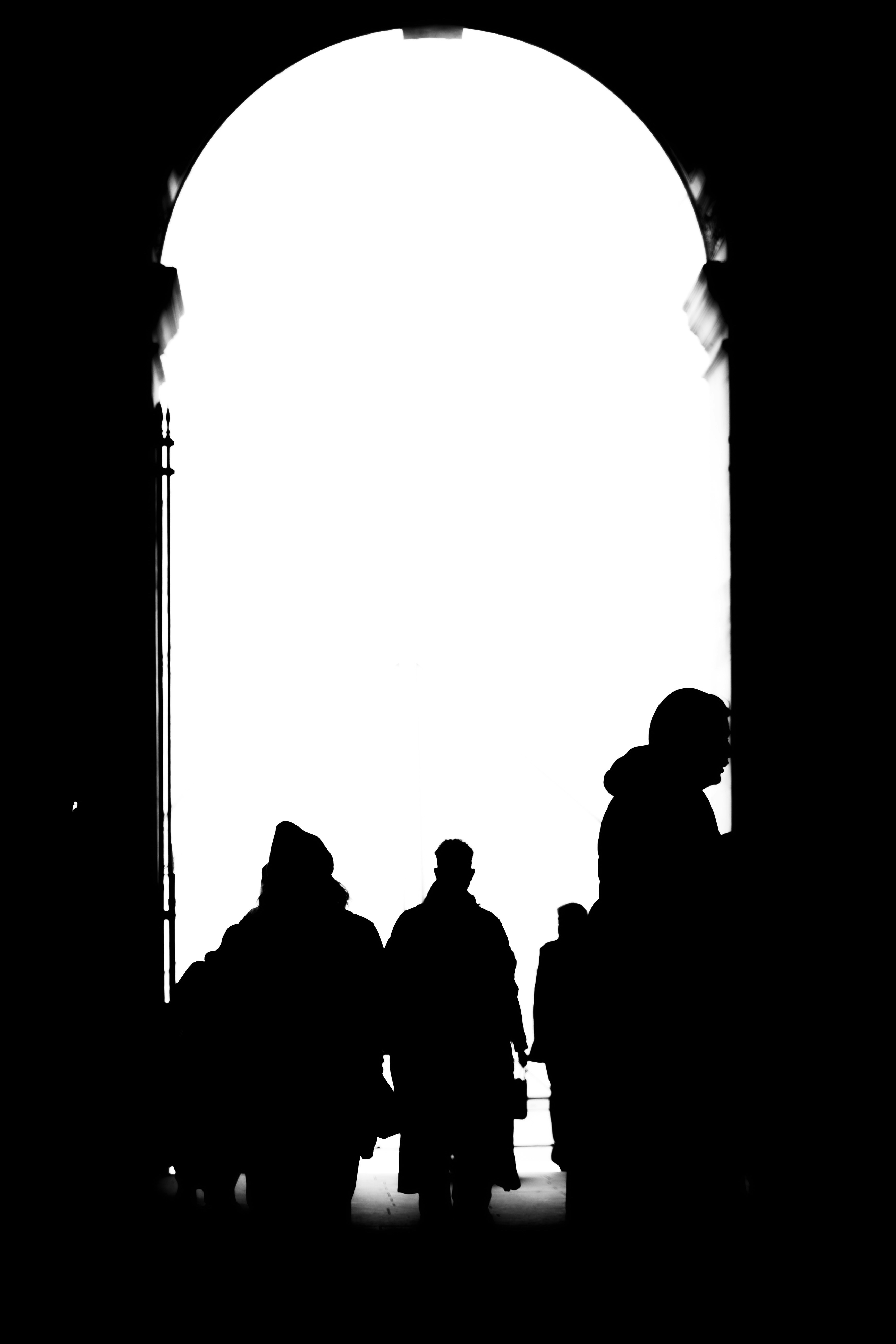  silhouettes under a grand archway 