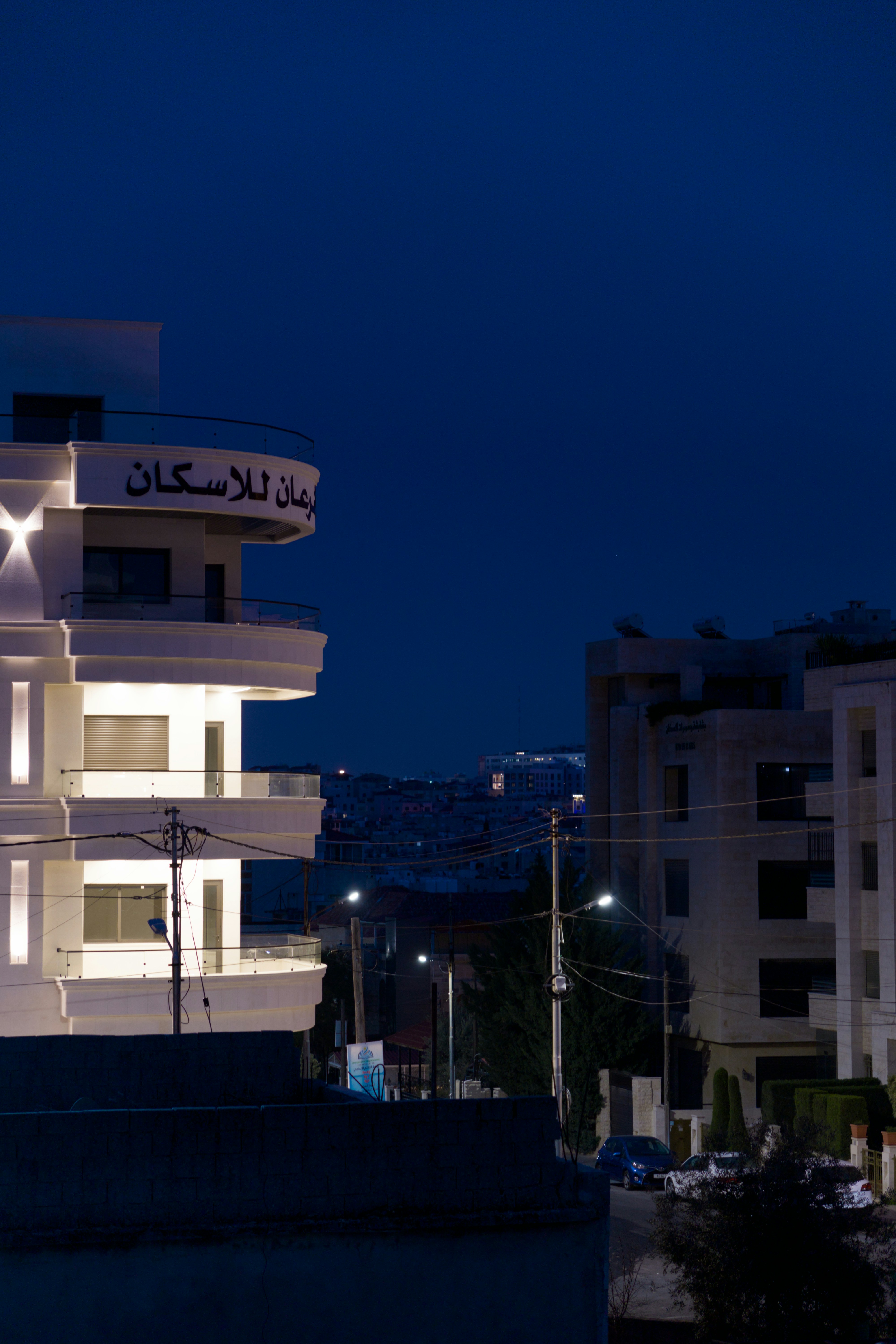 Nighttime City Balcony: A Modern Residence Under Deep Blue Sky